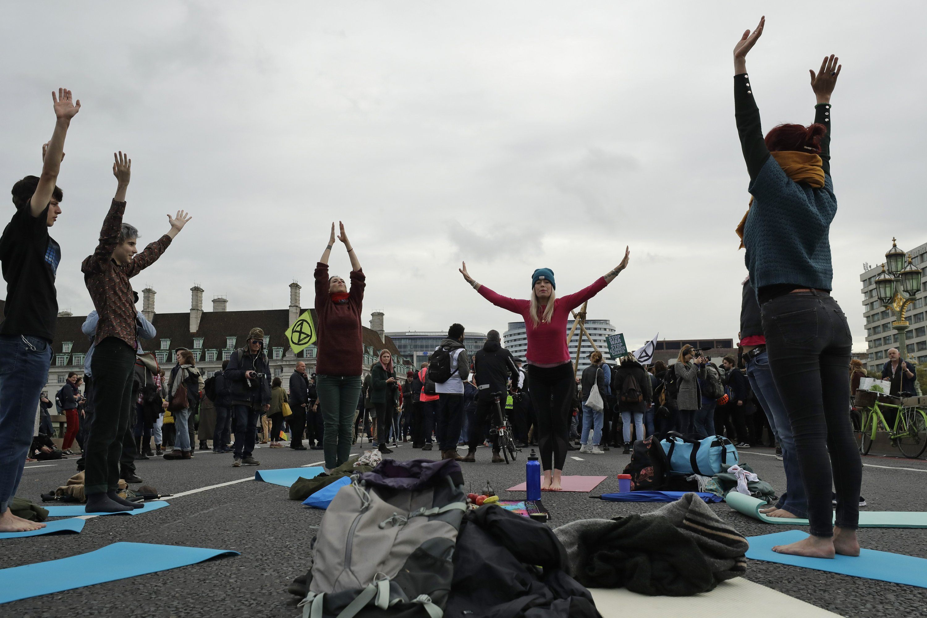 The Latest: Climate protesters douse famous Wall Street bull | AP News