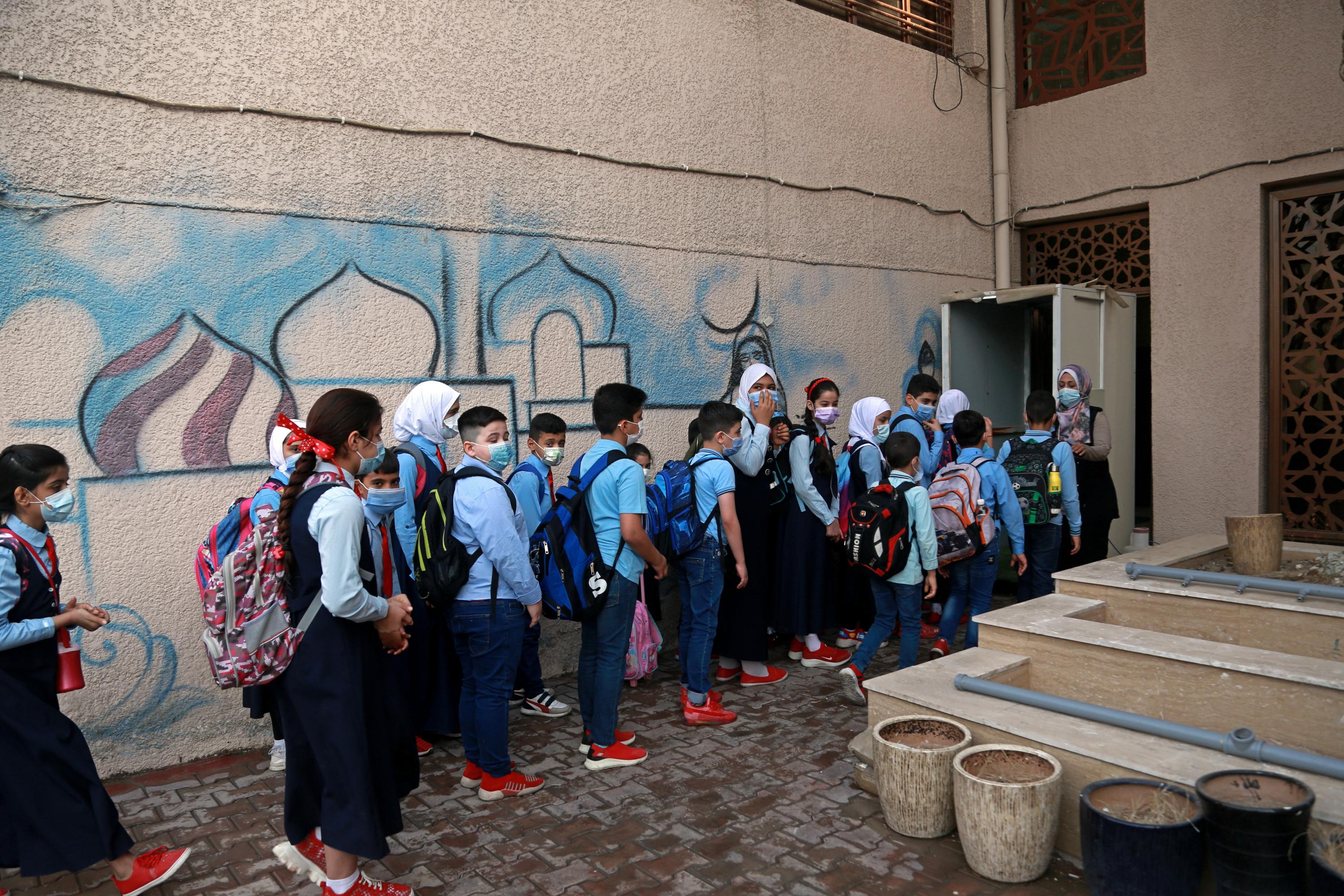 After a year, Iraq students back in school as pandemic slows | AP News