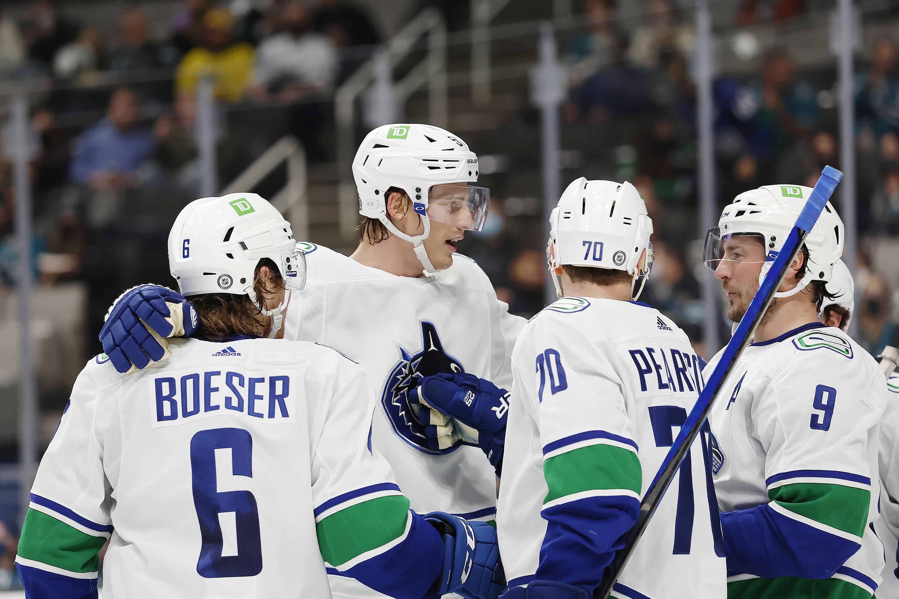 Boeser scores twice to lead surging Canucks past Sharks 5-2 | AP News