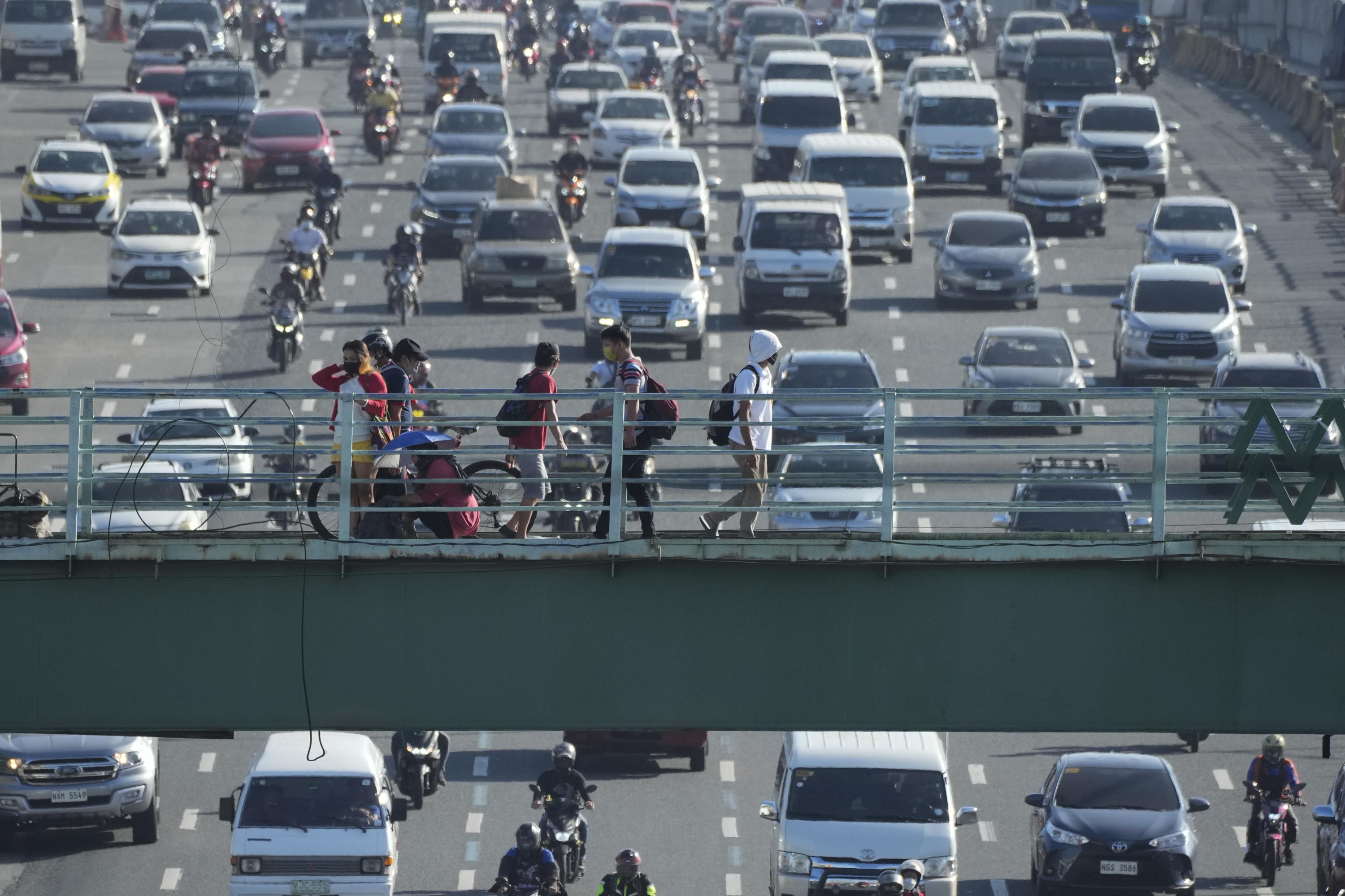 Traffic jams back in Philippine capital as restrictions ease | AP News