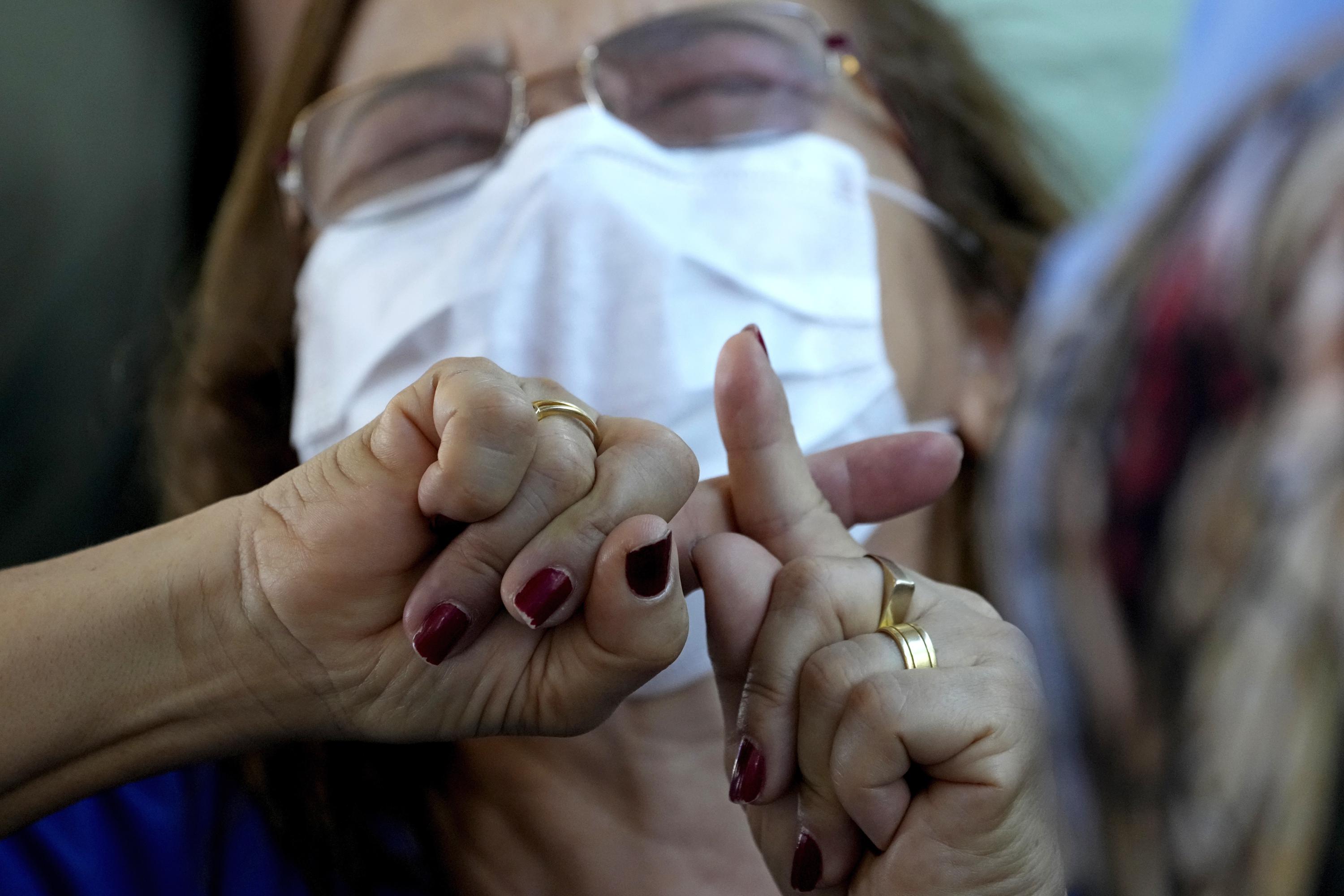 Rio relaxes the use of masks as pandemic wanes in Brazil | AP News