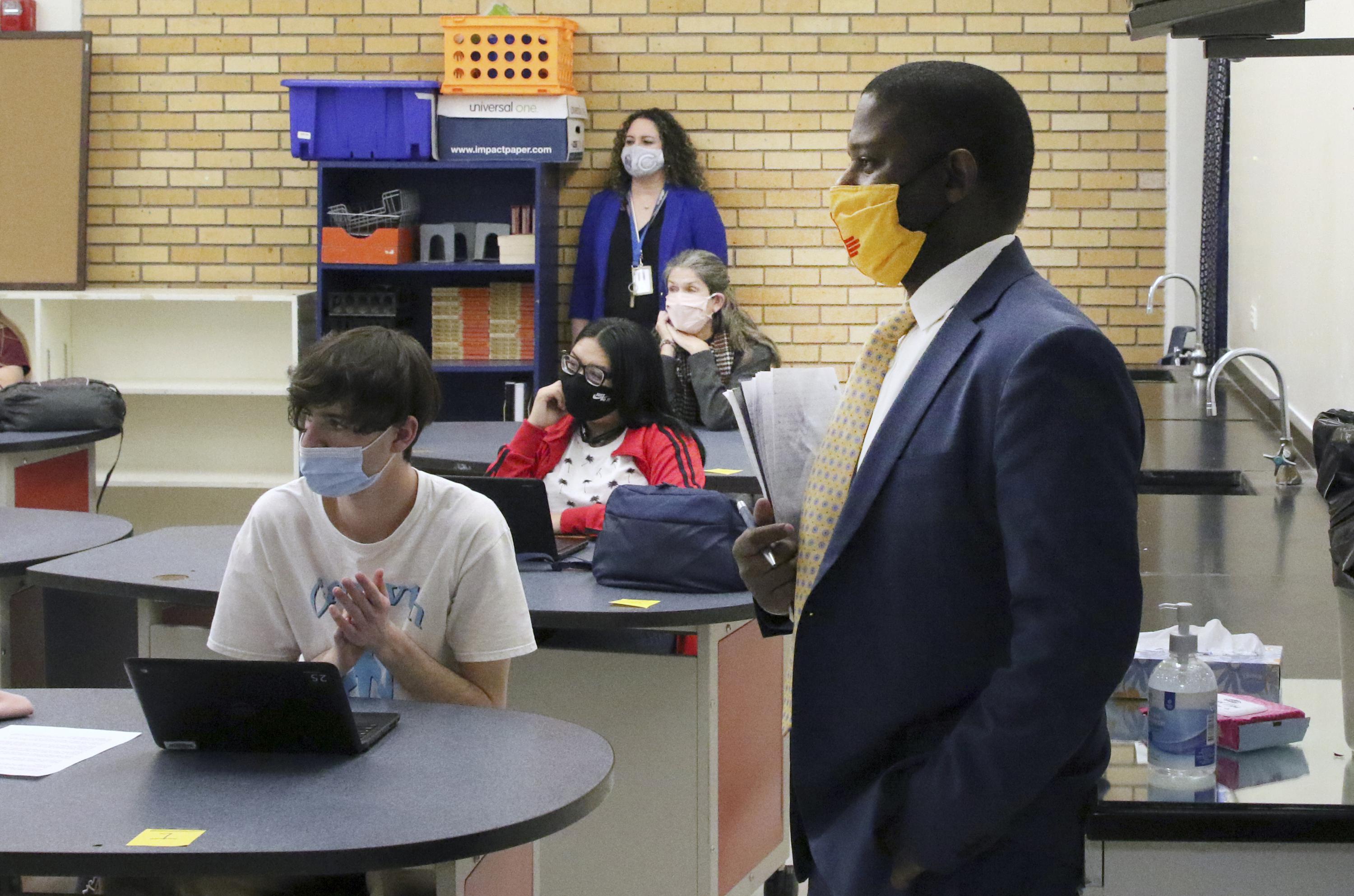 Poverty pilot program sends millions to poorest schools | AP News