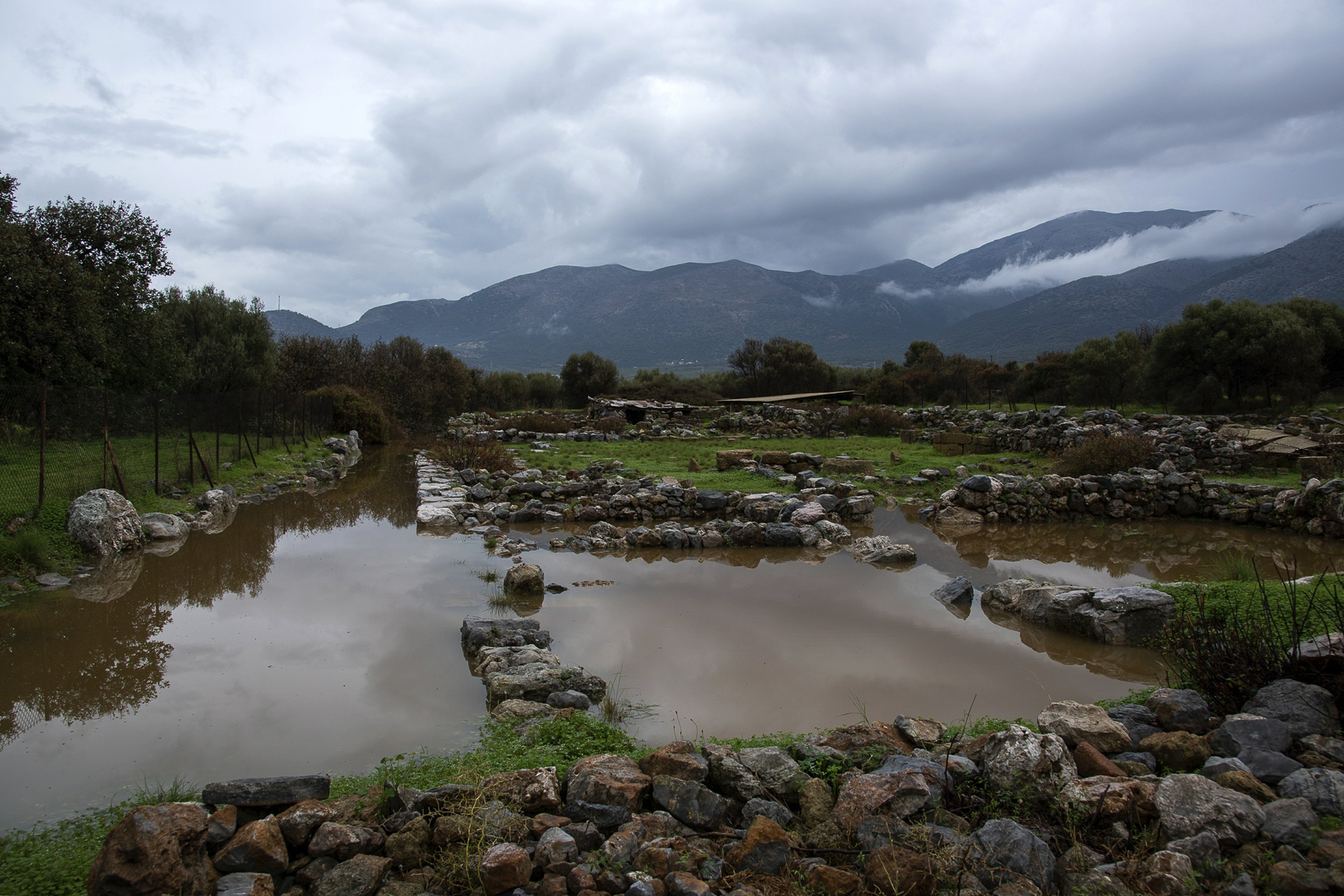 Greece: Floods sweep cars into sea, send people to rooftops | AP News