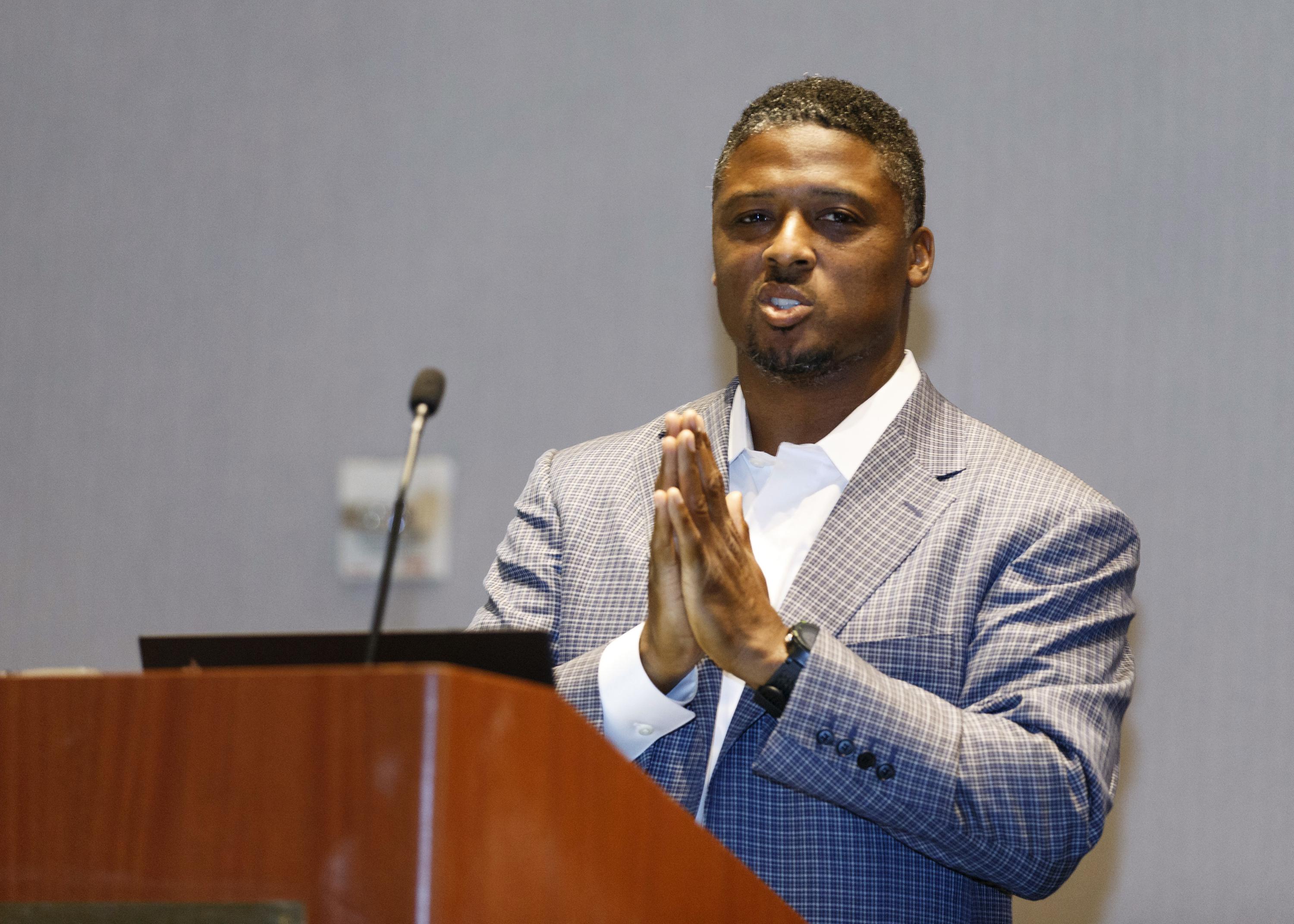Former NFL star Warrick Dunn tackles housing inequalities | AP News