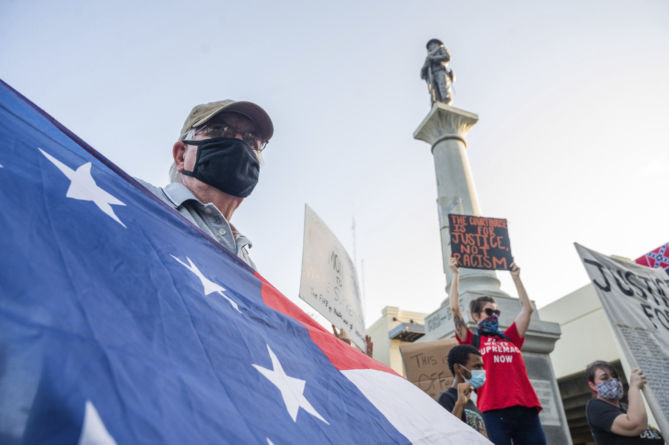 Confederate statue protest turns tense after militia arrives | AP News