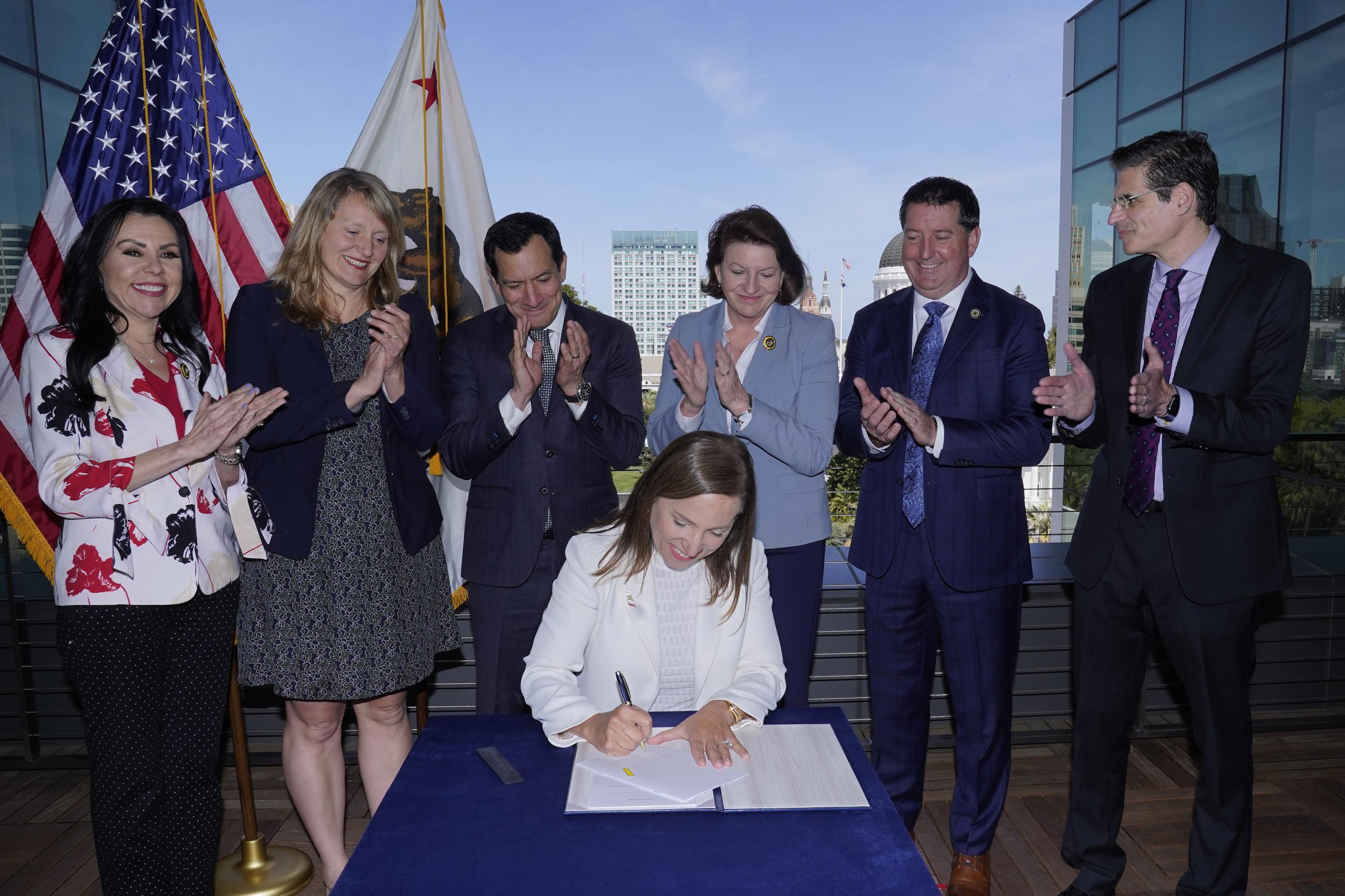 A California first: woman signs bill into state law | AP News