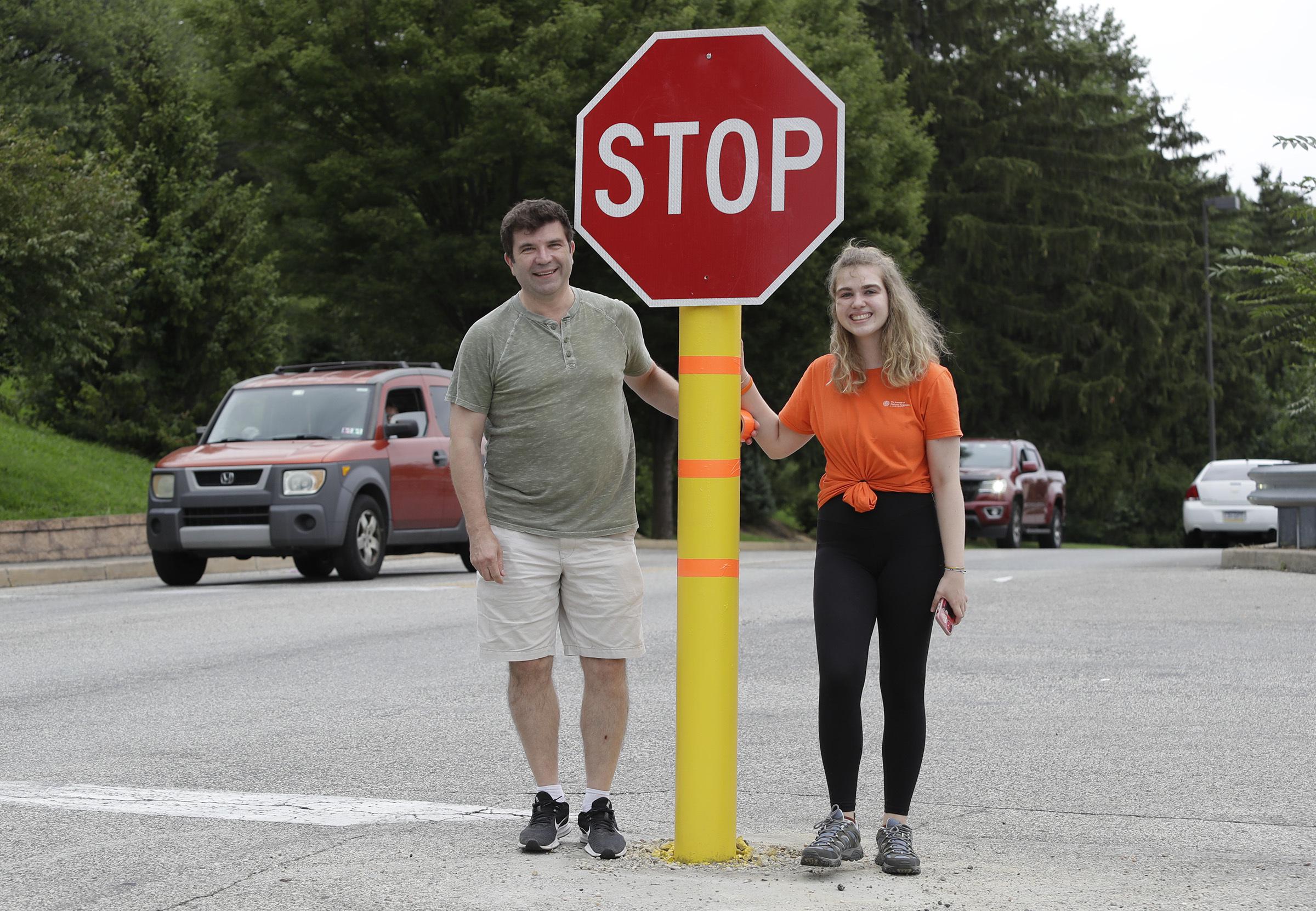 Stop sign often knocked down becomes beacon of resiliency | AP News