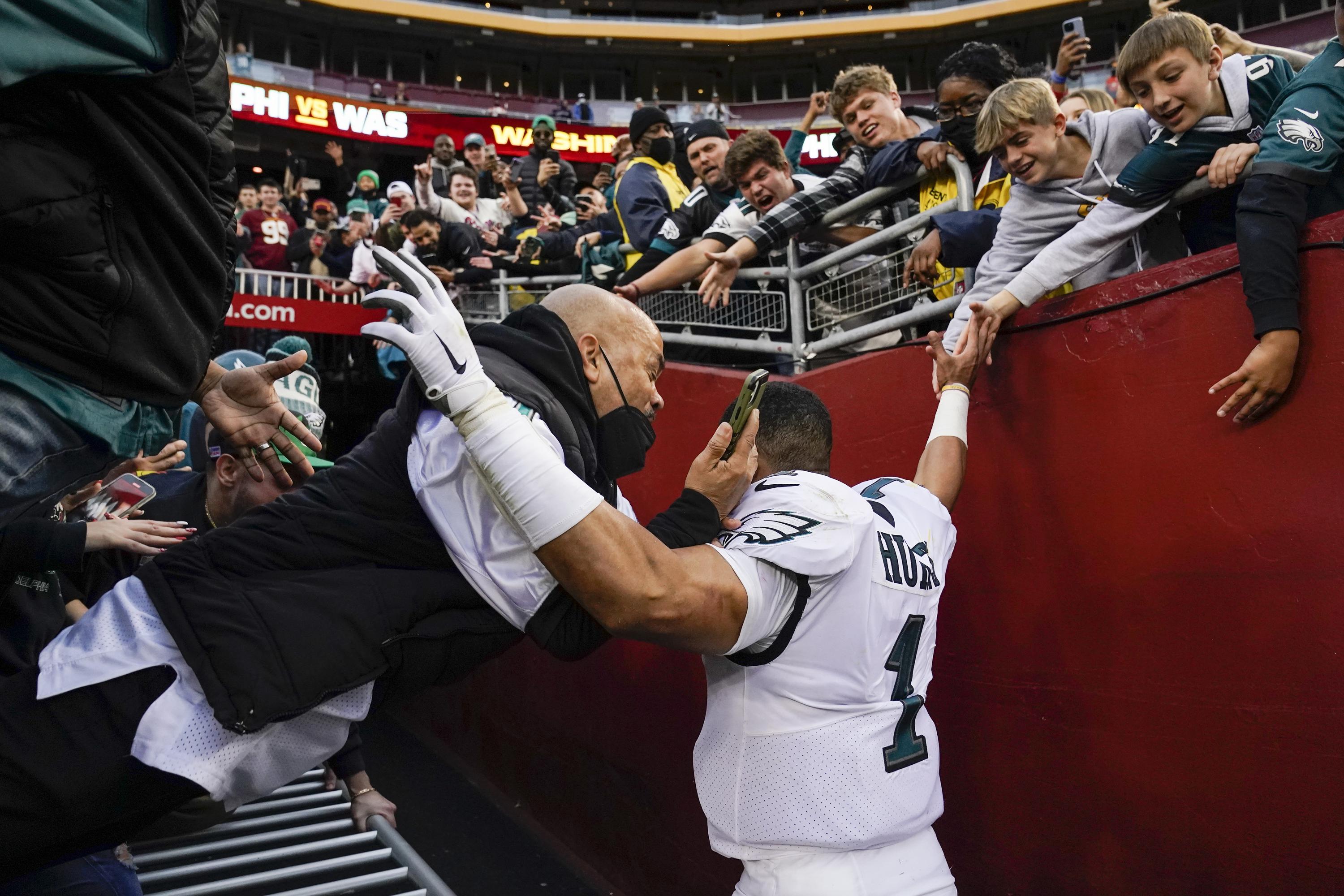 Eagles beat Washington, get help to clinch playoff berth | AP News