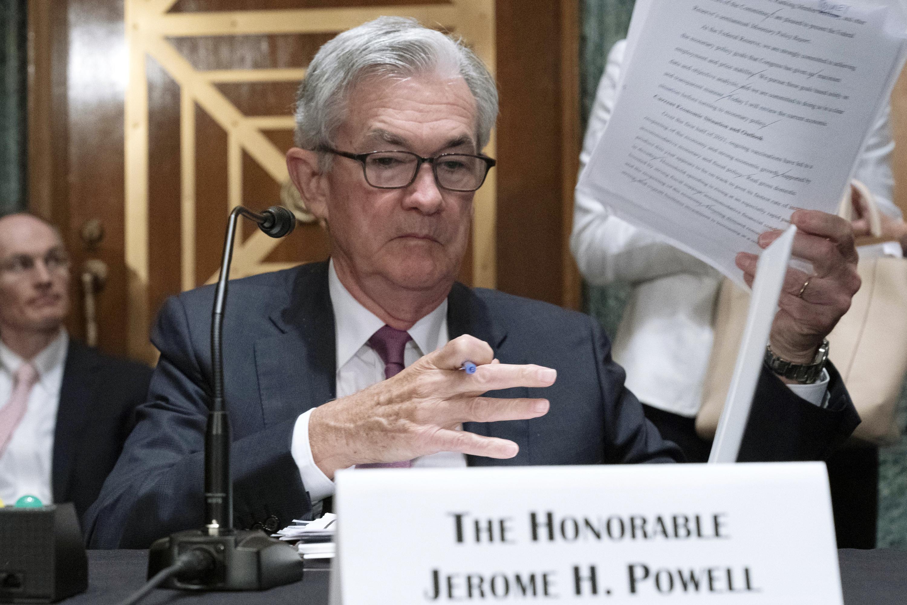 Under pressure, Powell says Fed to revamp its trading rules | AP News