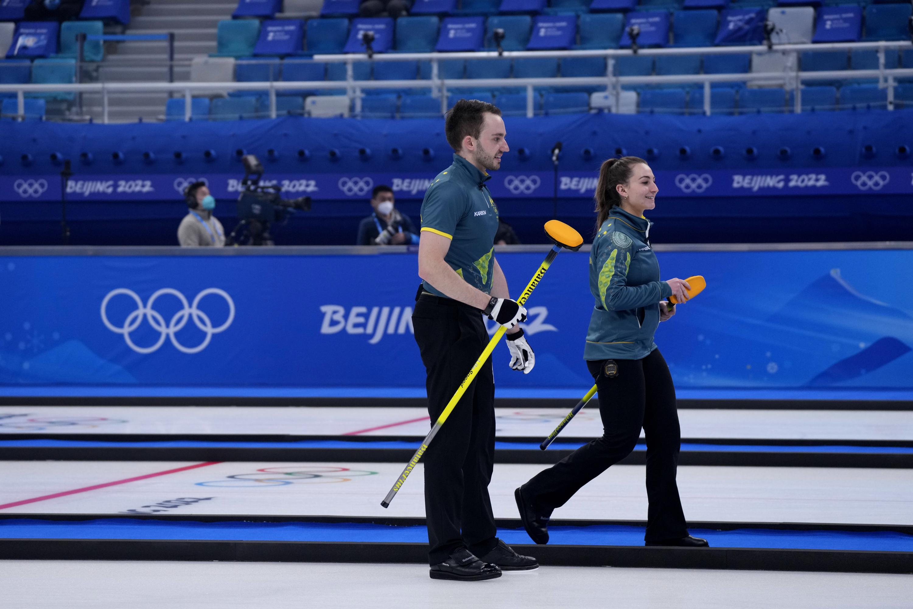 Aussies curlers out of Olympics, back in, then win 1st game | AP News