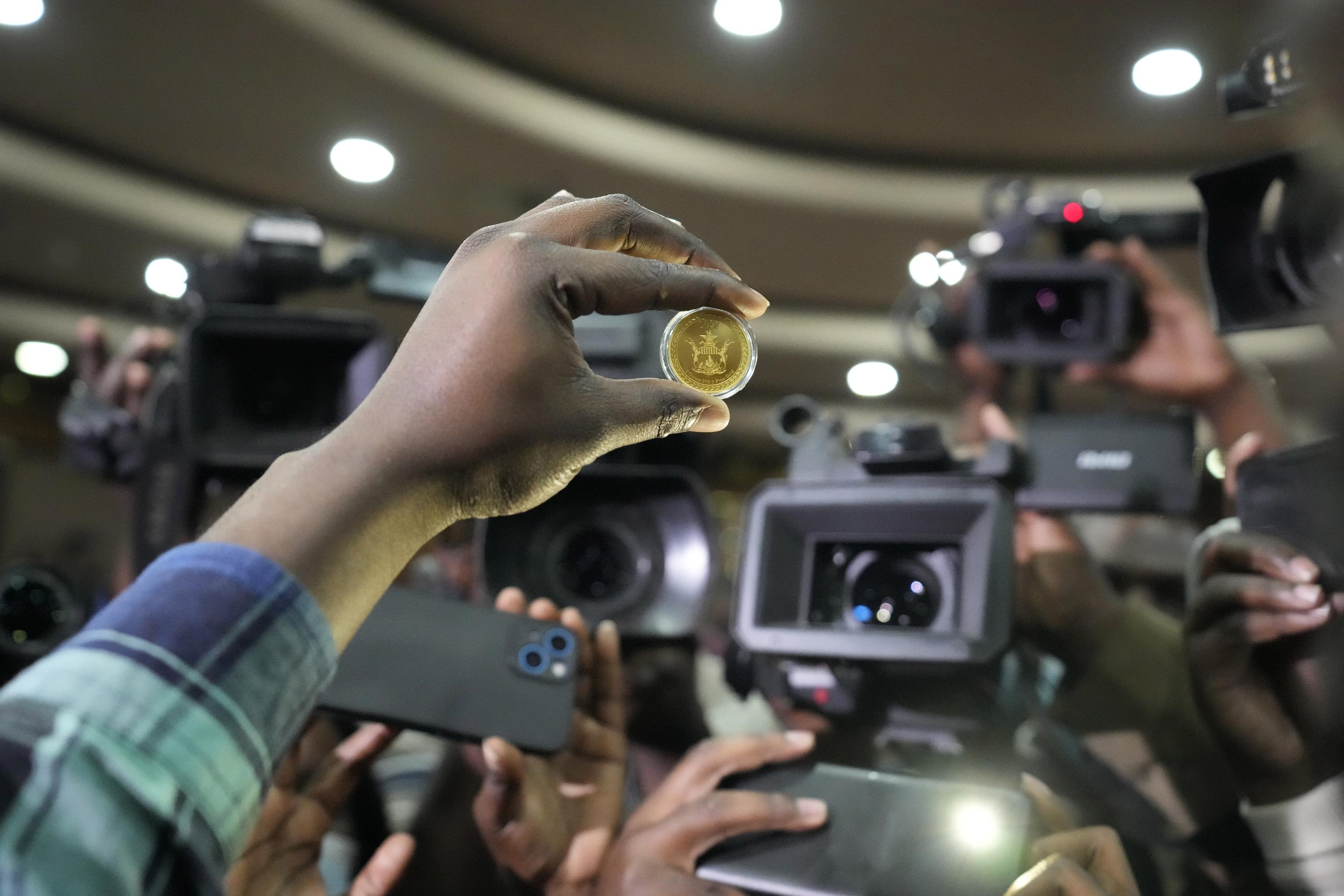 Zimbabwe debuts gold coins as legal tender to stem inflation | AP News