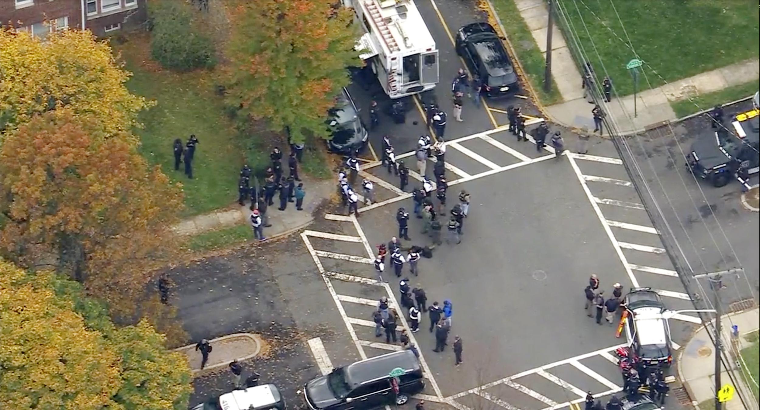 2 police officers shot in Newark; suspect at large | AP News