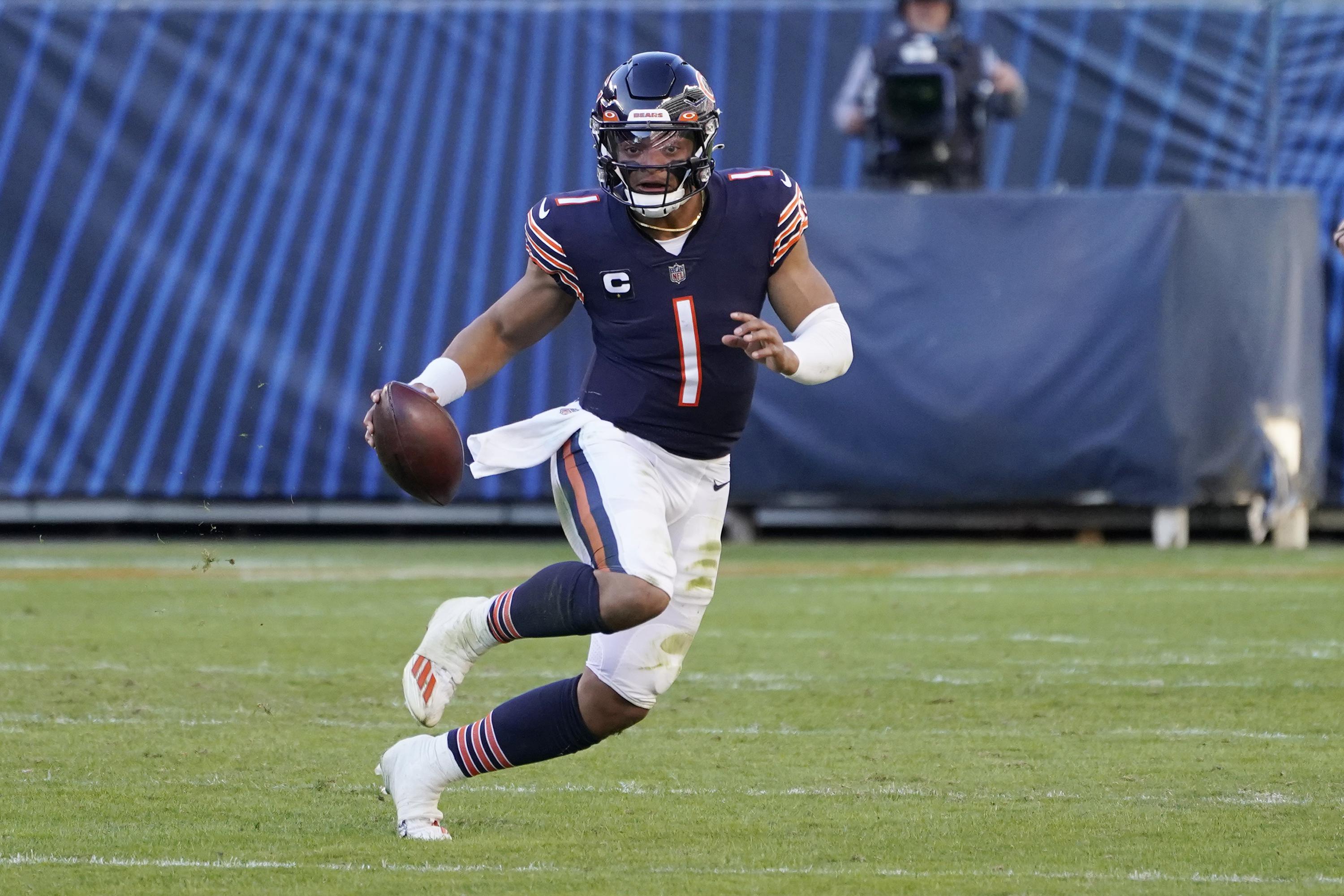 Bears QB Fields rushes for 178 yards in loss to Dolphins | AP News