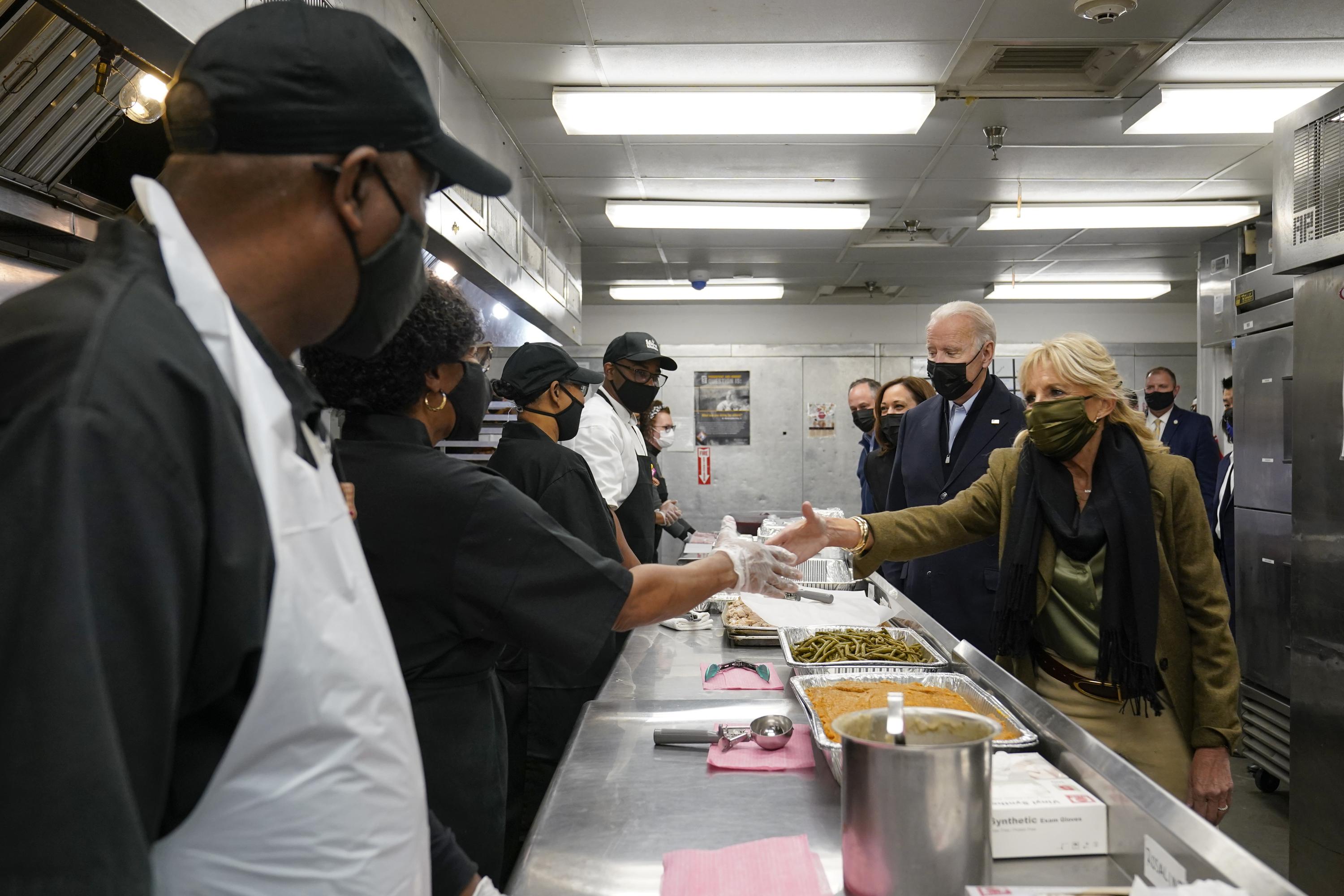 President, VP and spouses assist food kitchen for holiday | AP News