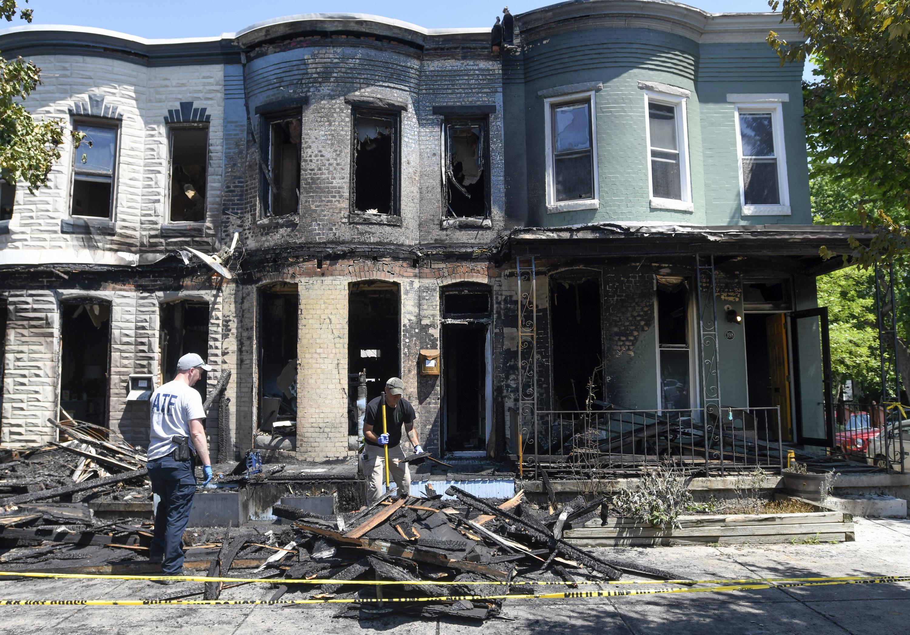 3 hurt in fire in row homes on block where pride flag burned | AP News