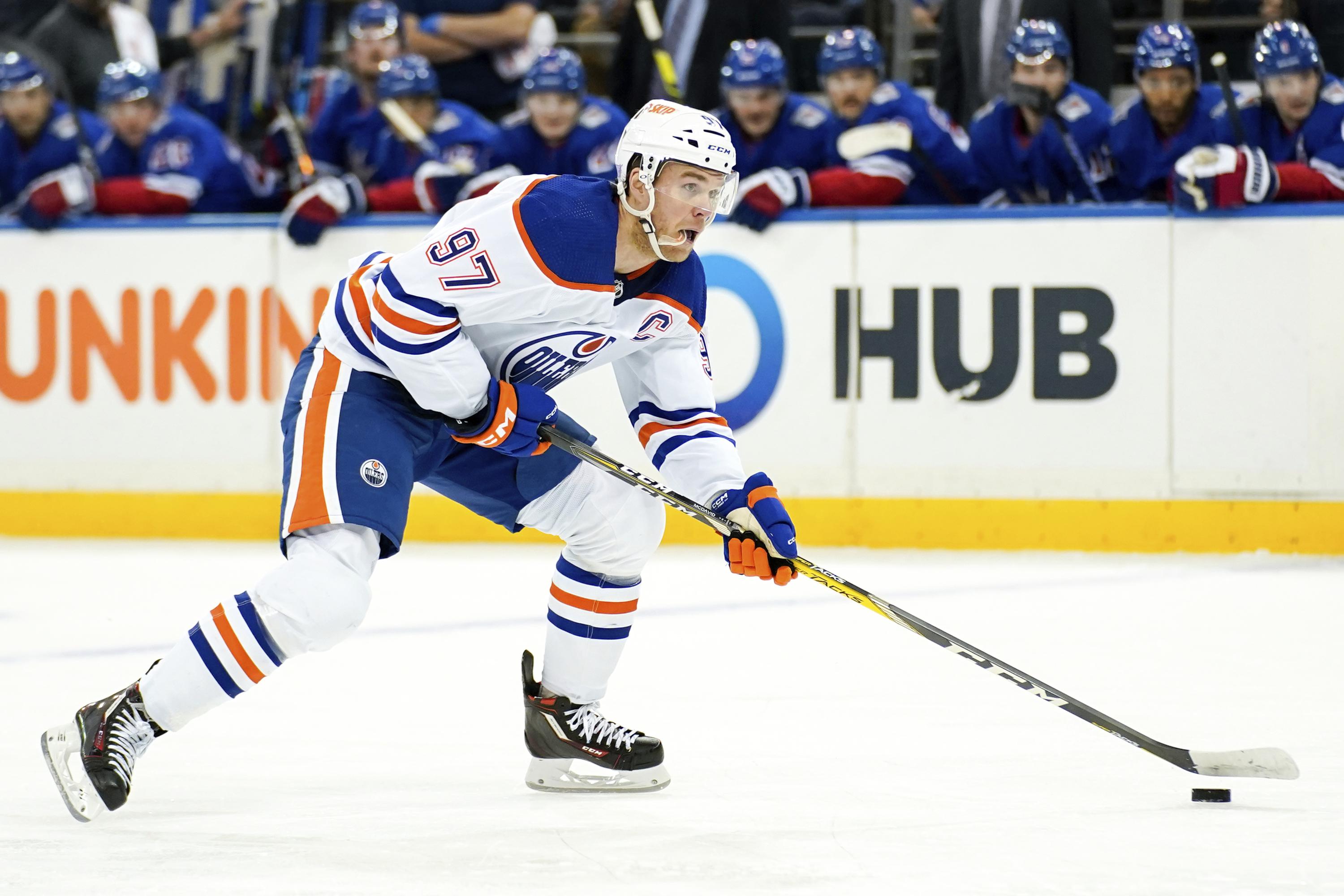 Oilers score 4 times in third period to defeat Rangers | AP News