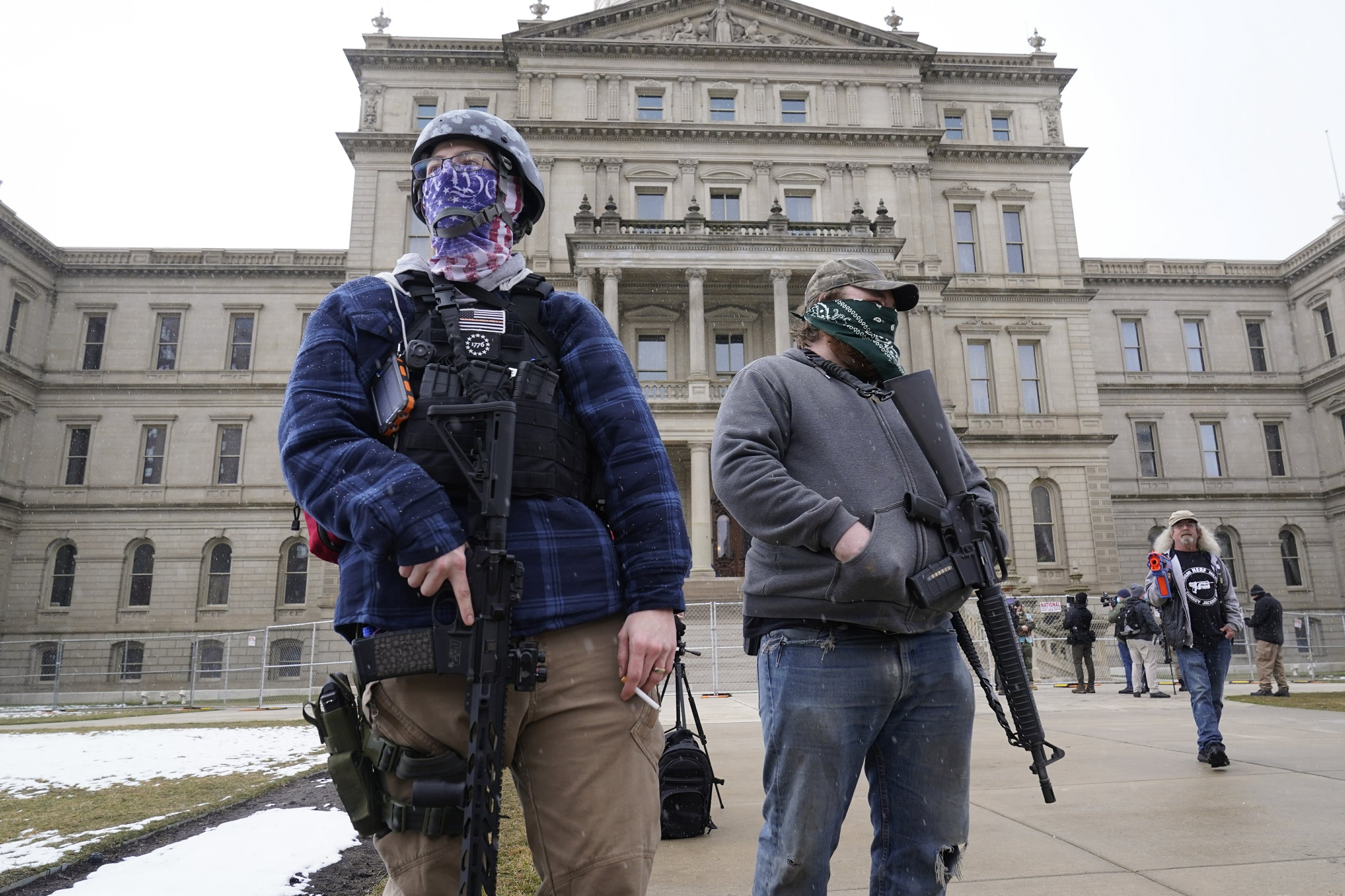 Small group of armed protesters dwarfed by police at Capitol | AP News