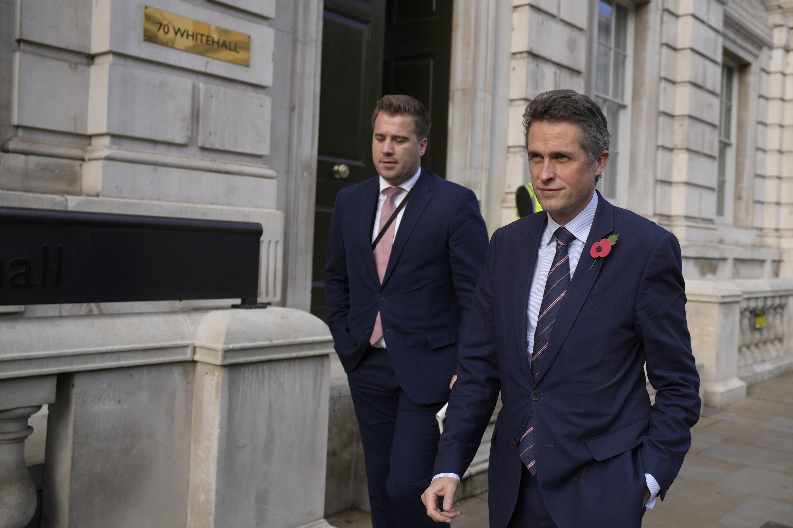 Senior UK government member resigns amid bullying claims | AP News