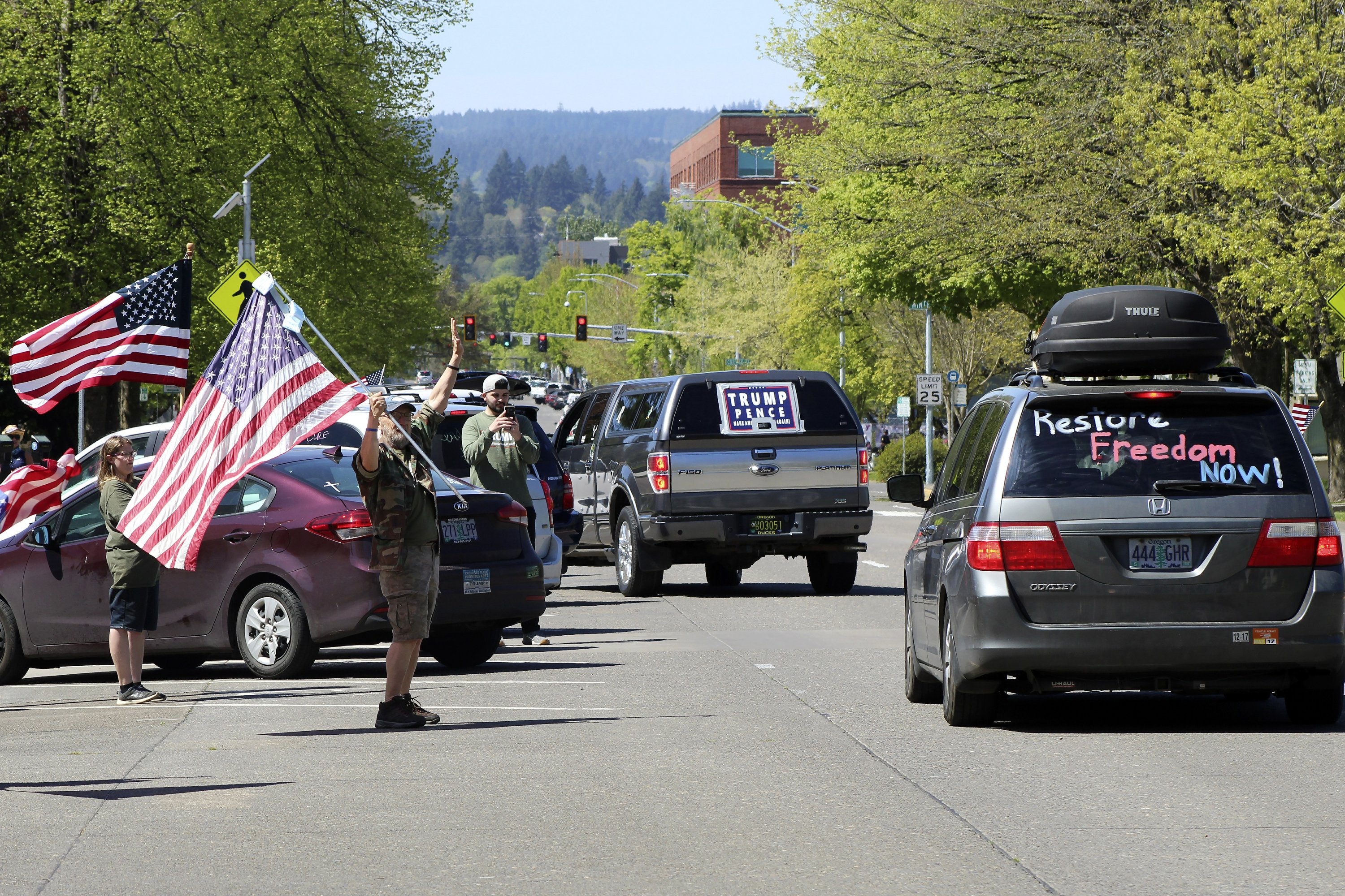 Dozens protest Oregon's stay-at-home order at Capitol | AP News