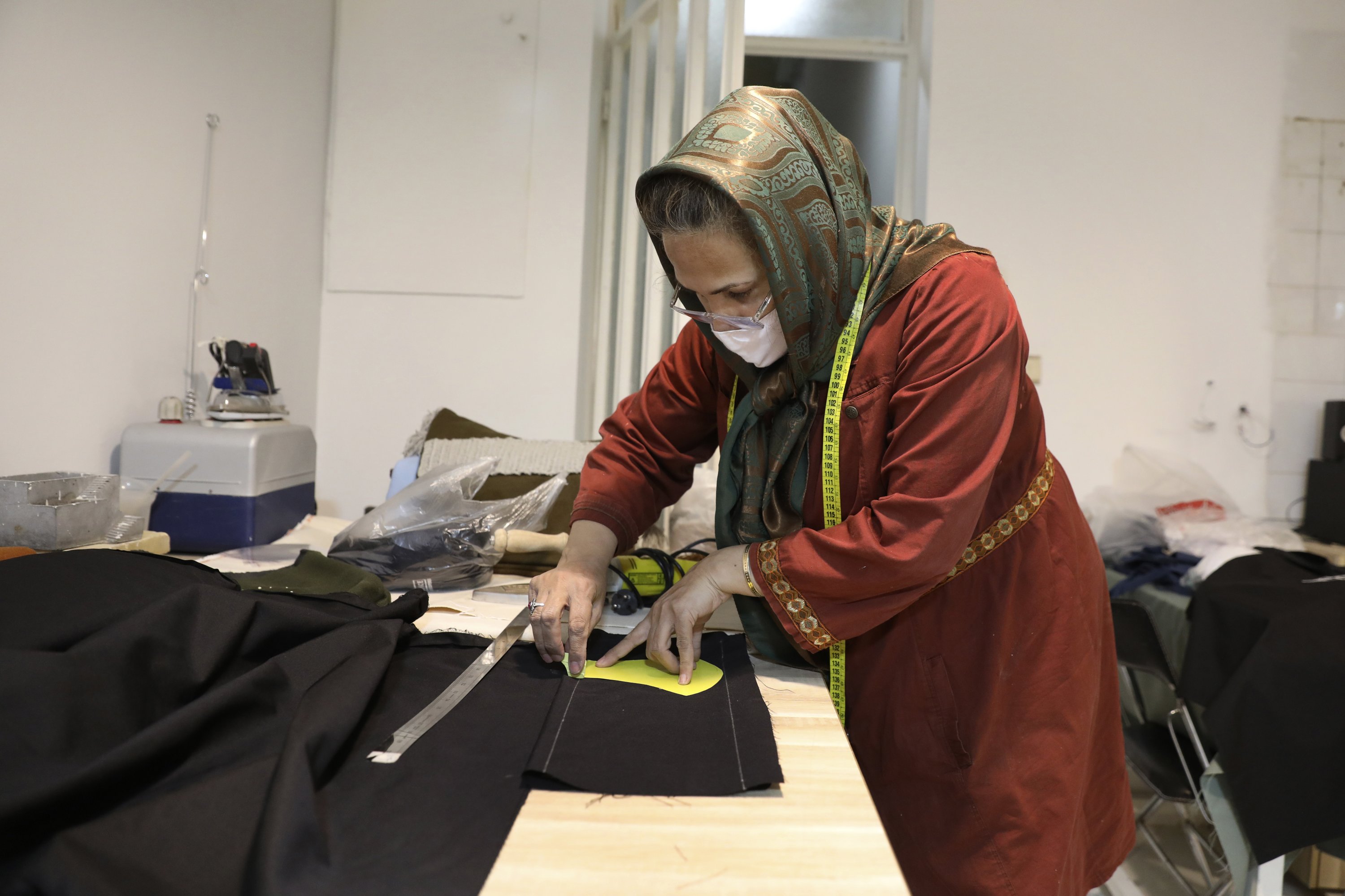 Iranian women's group empowers amid pandemic by making masks | AP News