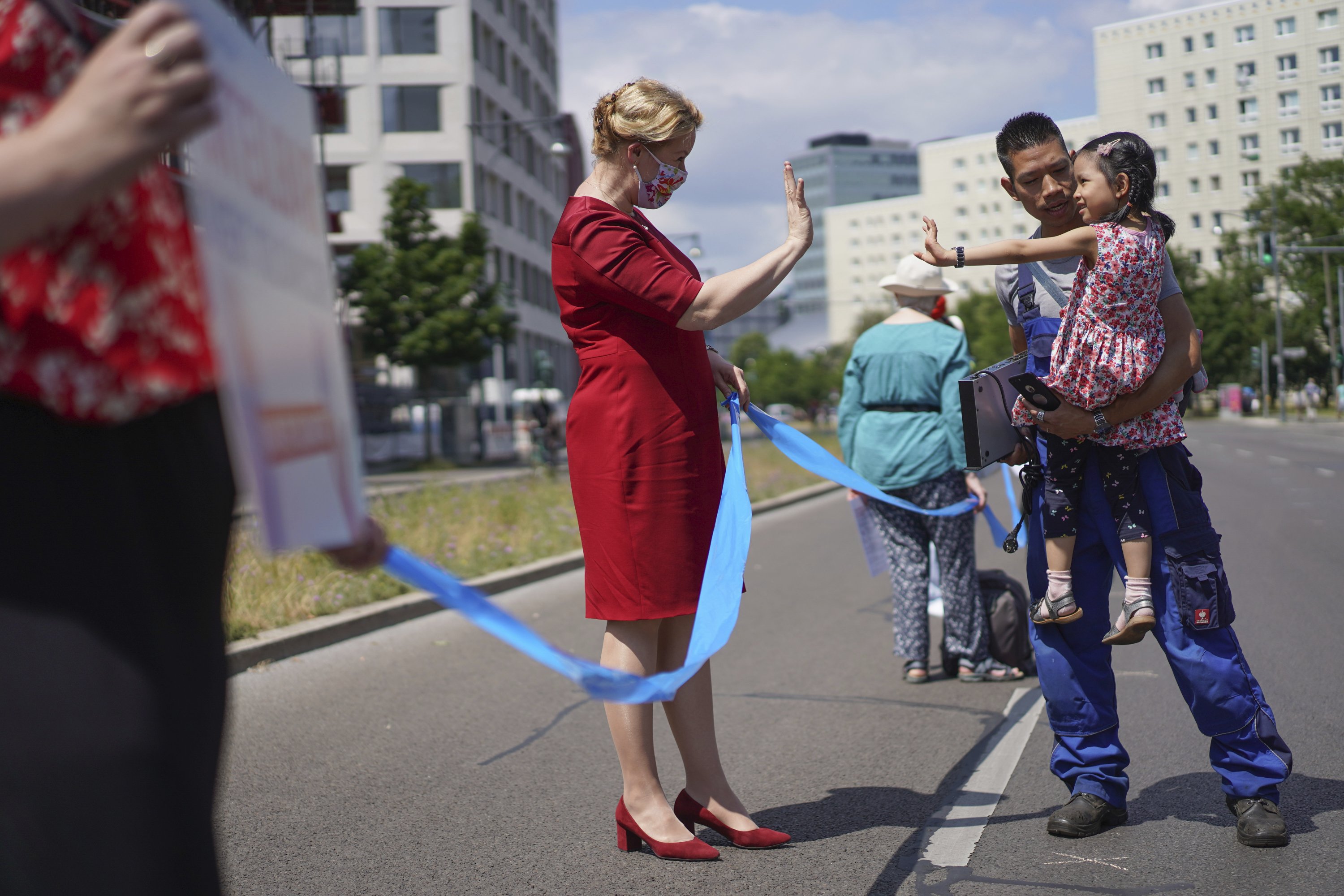 Thousands form human chain in Berlin against racism | AP News