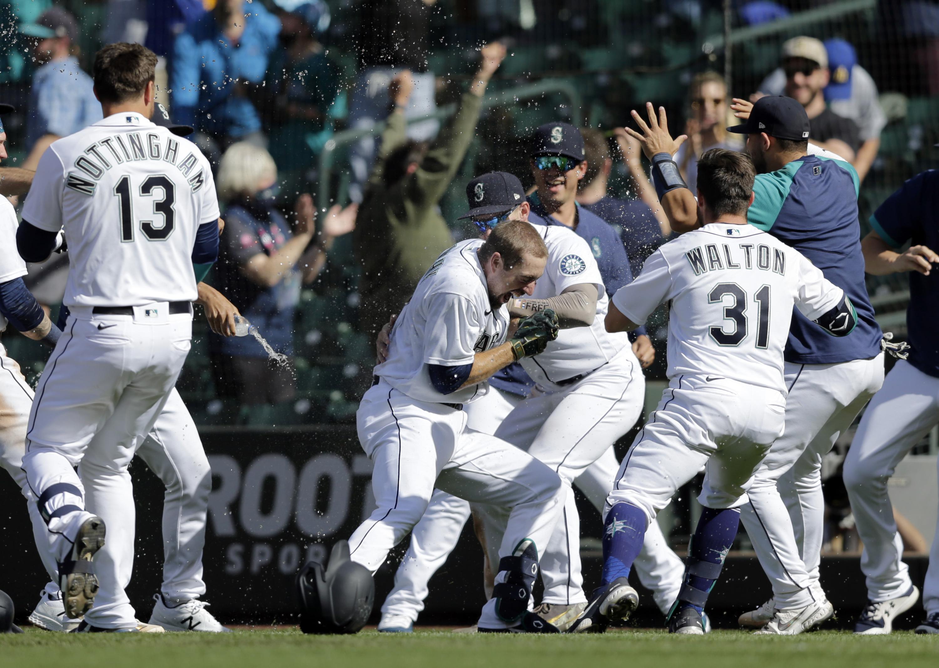 Mariners rally past A's in 10th, improve to 5-0 in extras | AP News