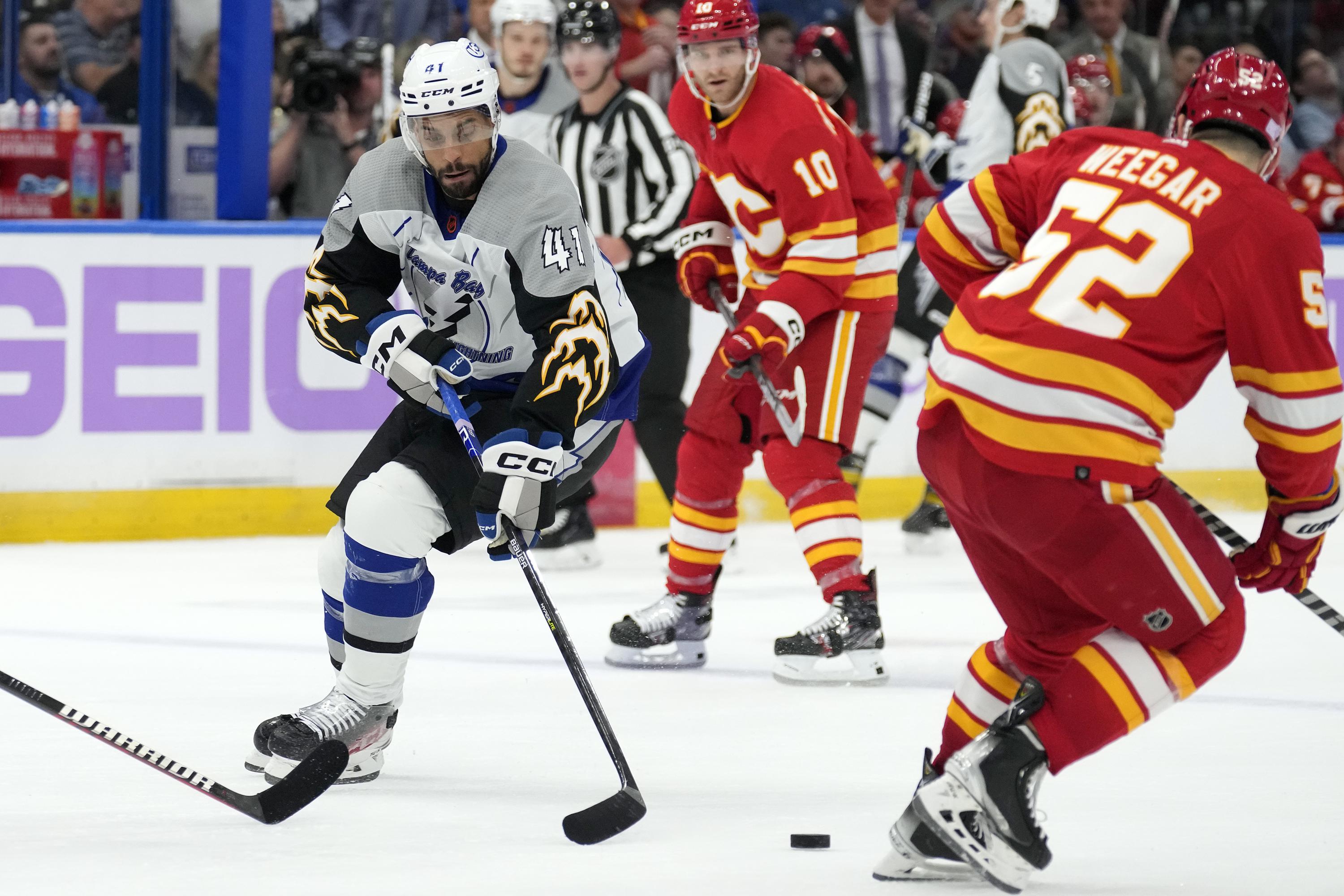 Kucherov, Vasilevskiy lead Lightning to 4-1 win over Flames | AP News
