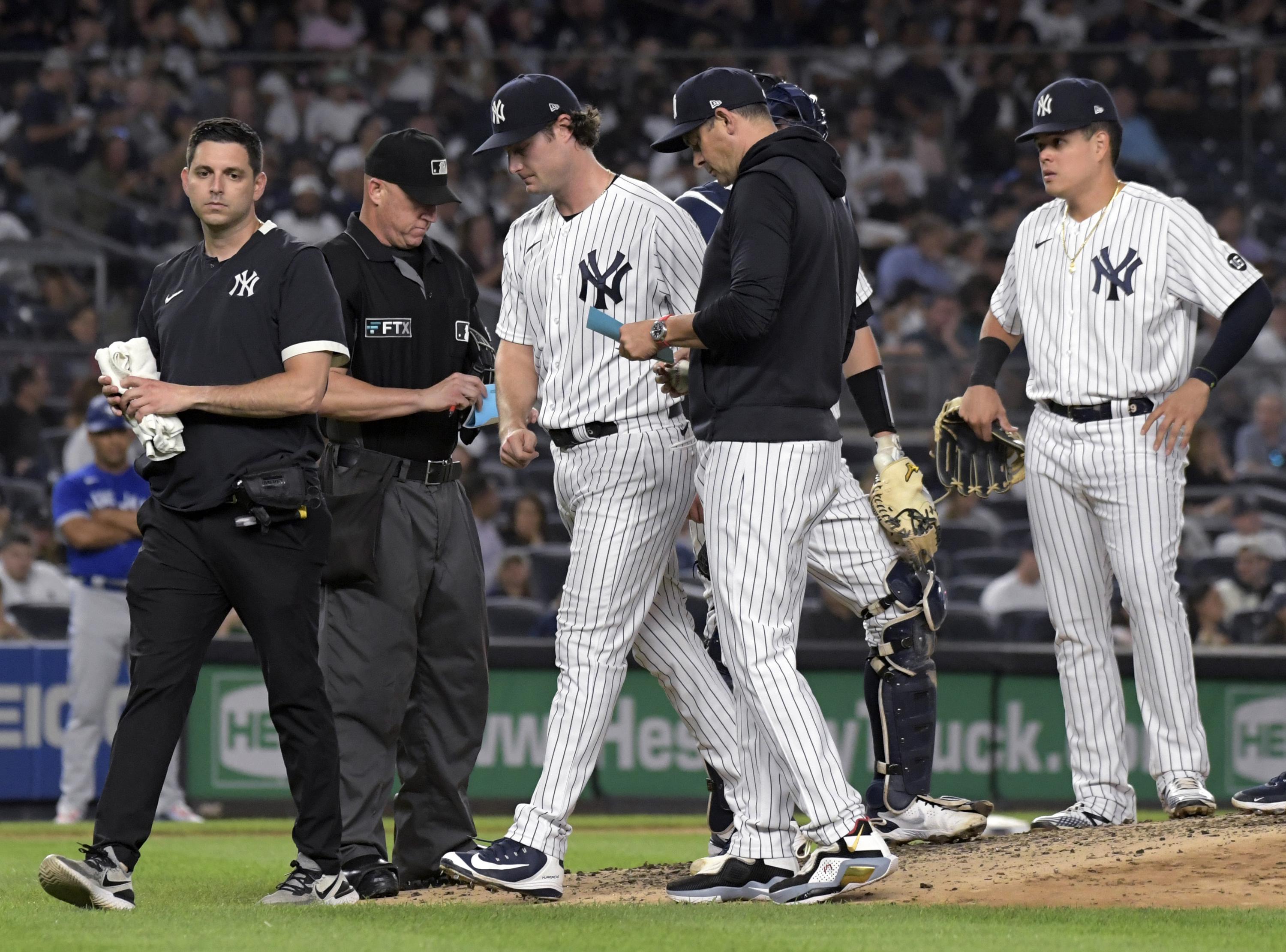Yankees ace Cole exits with tightness in his left hamstring | AP News
