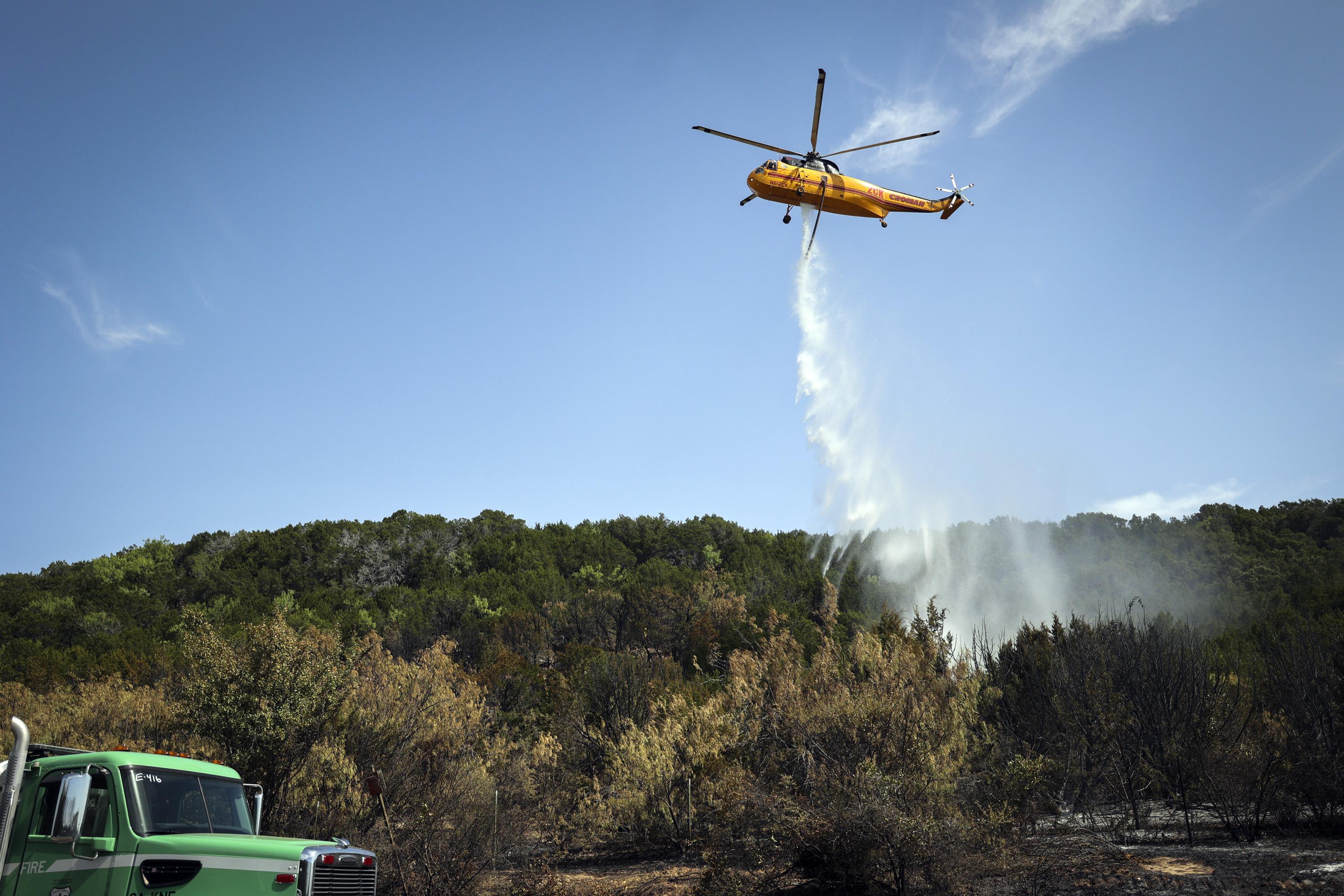 Crews make progress against destructive Texas wildfires | AP News