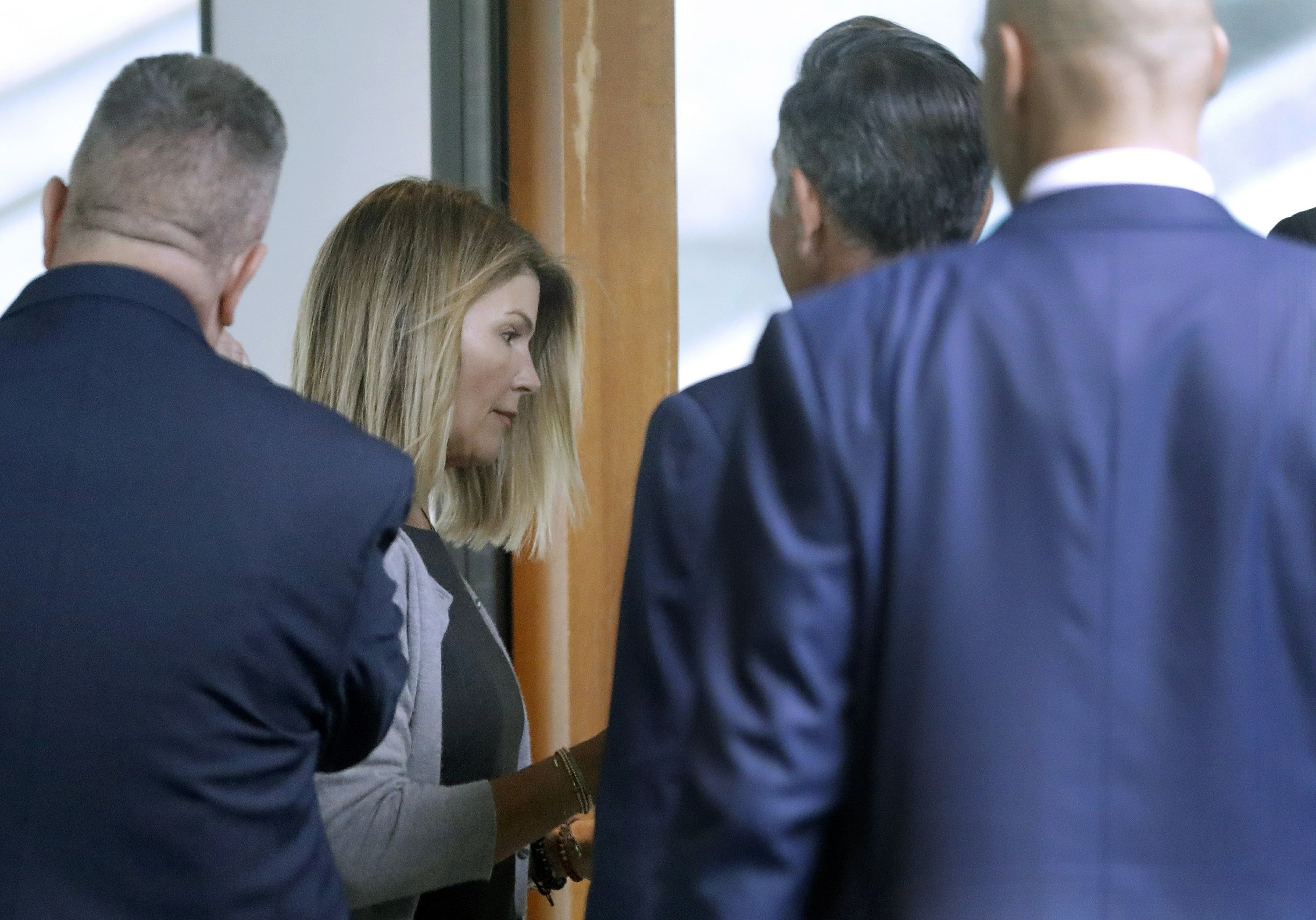 Judge says Loughlin, husband can stick with their law firm | AP News