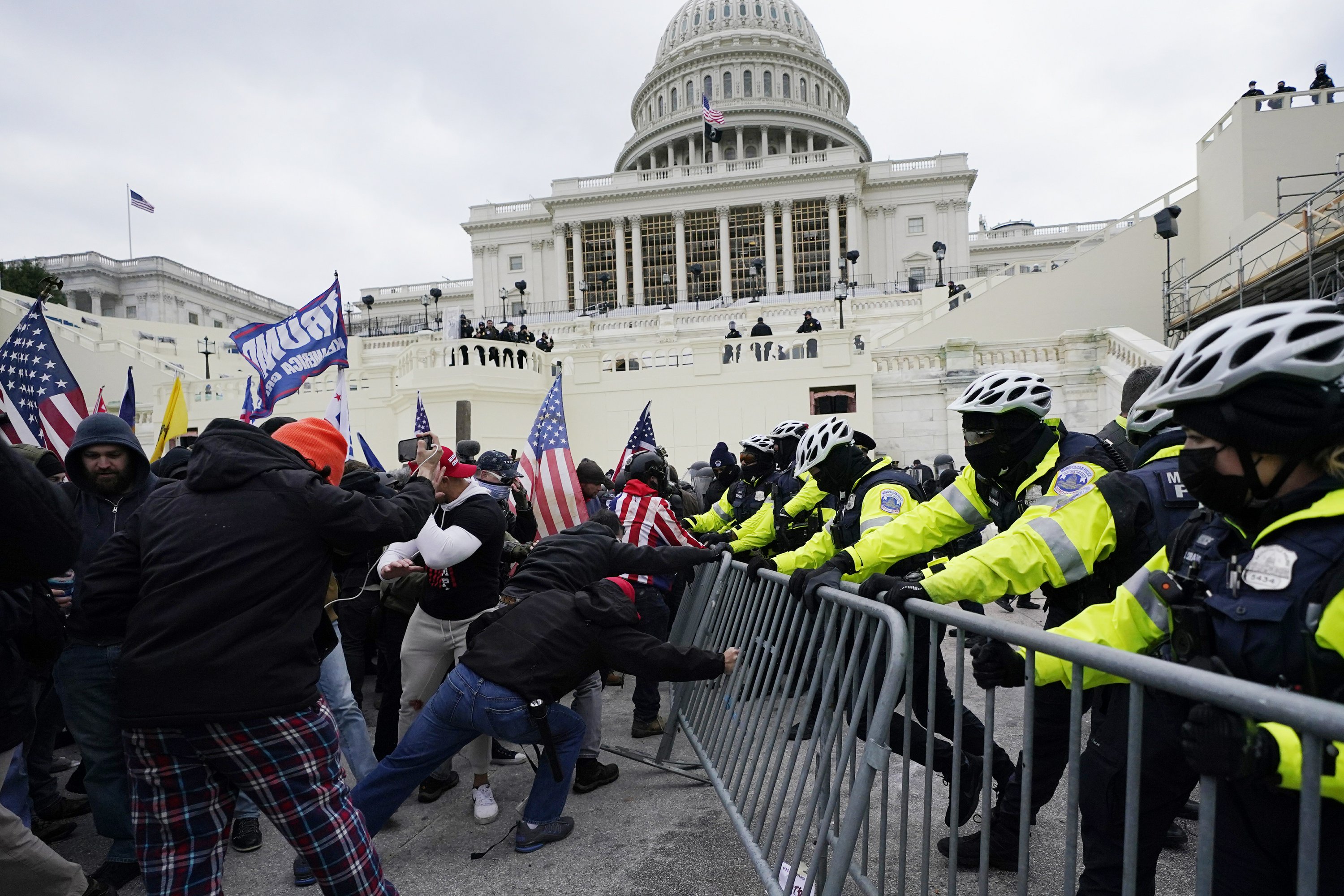 Dozens charged in Capitol riots spewed extremist rhetoric | AP News