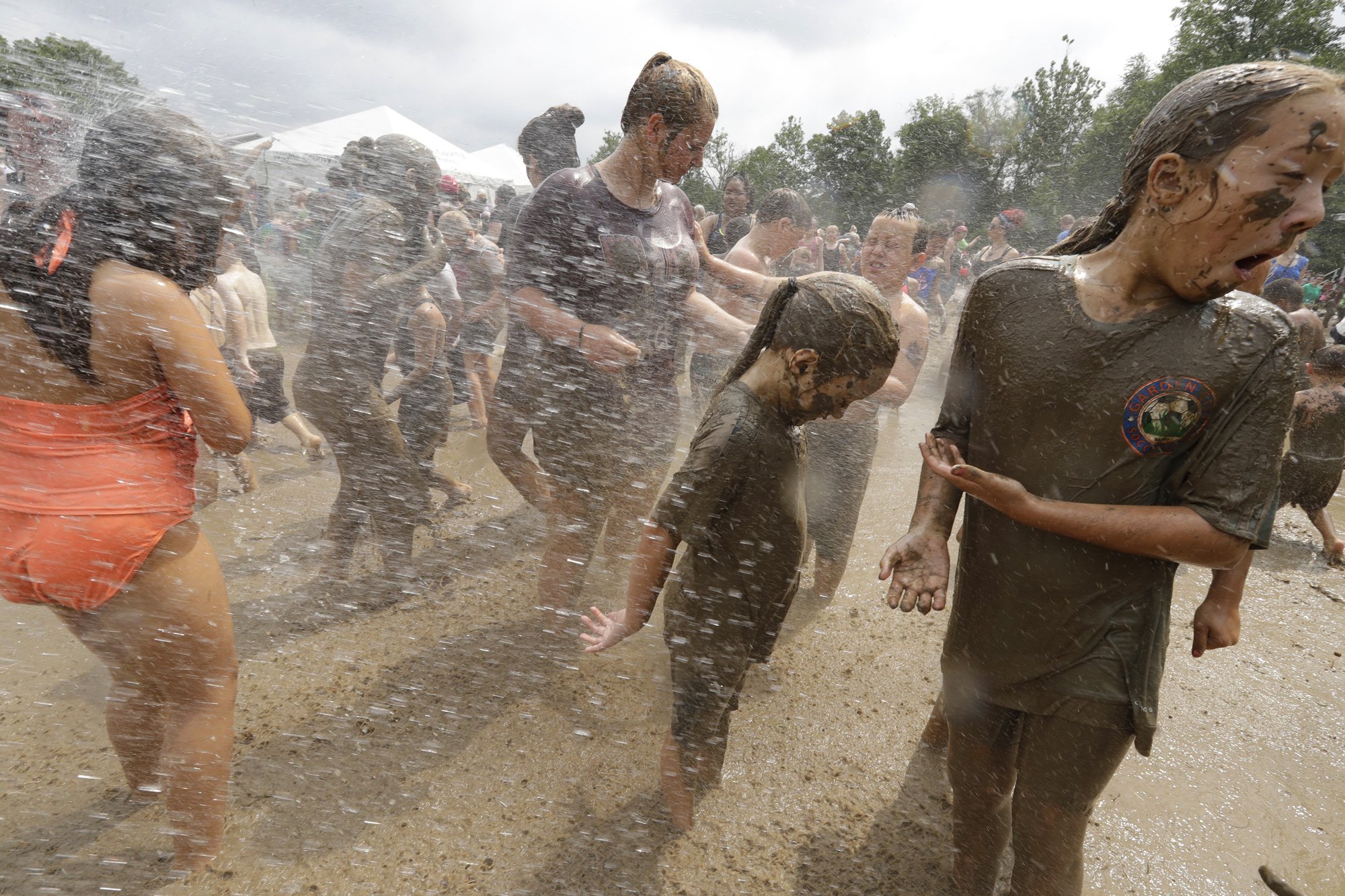 Kids get down and dirty at annual Mud Day event in Michigan | AP News