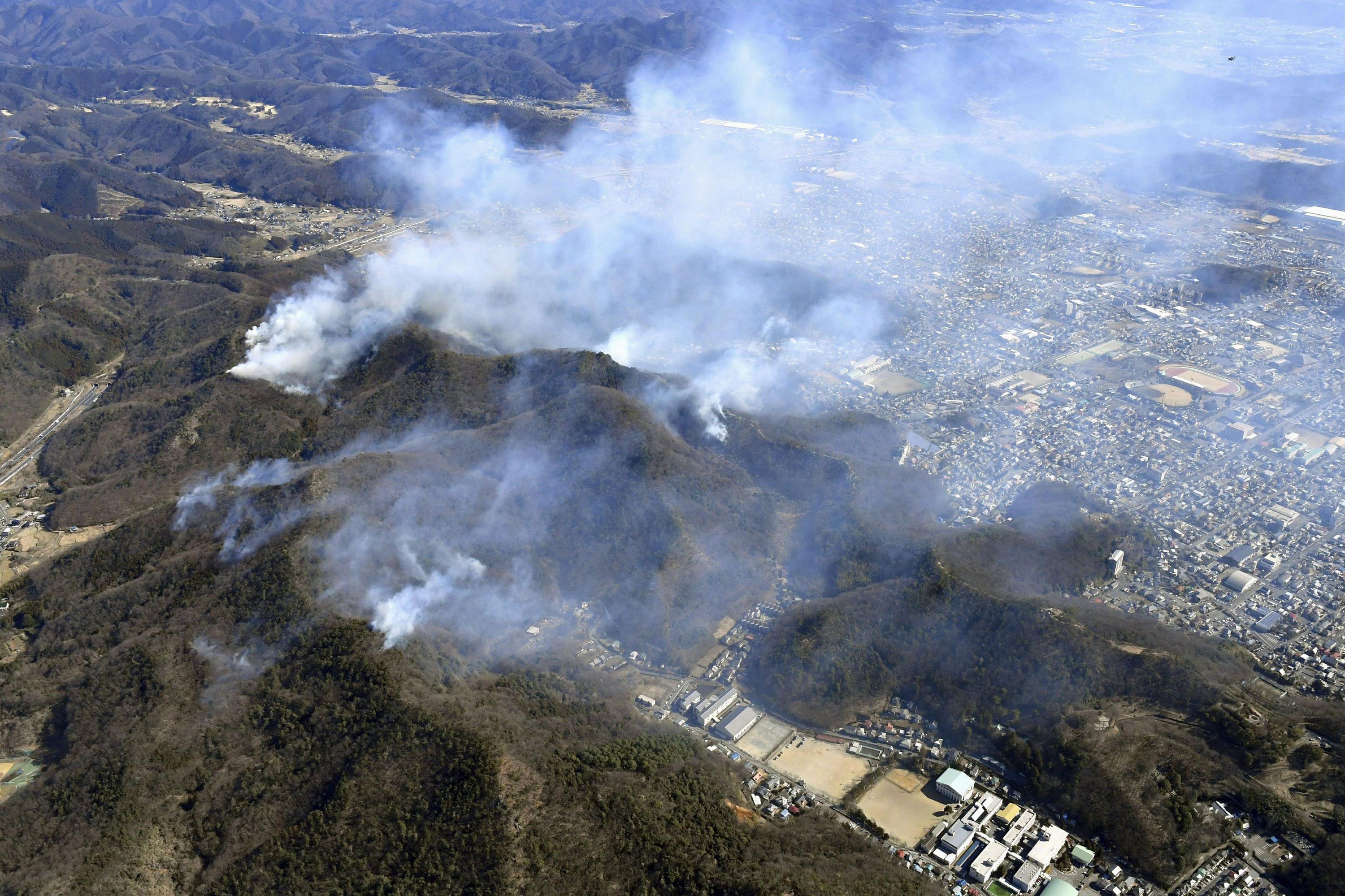 Helicopters, firefighters battle 2 forest fires in Japan | AP News