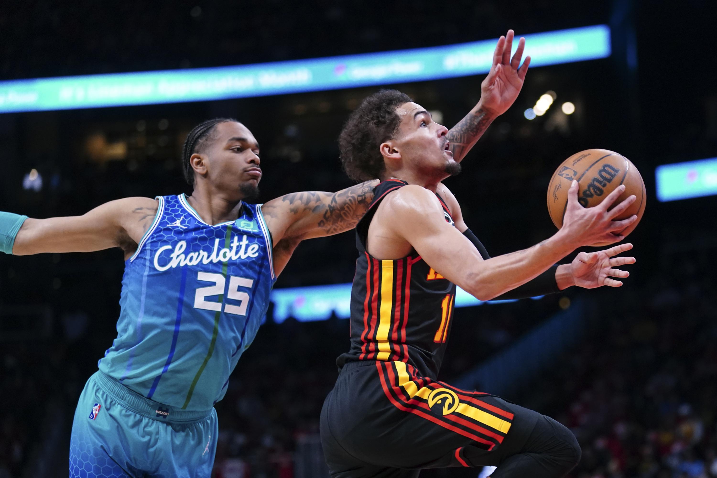 Young, Hunter carry Hawks past Hornets in play-in rout | AP News