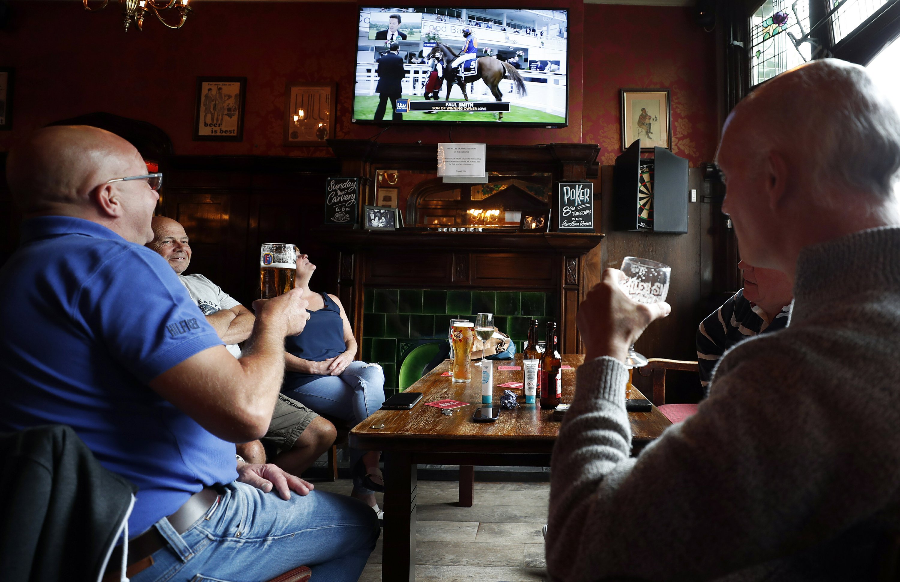 English pubs reopen but little normal elsewhere in the world | AP News