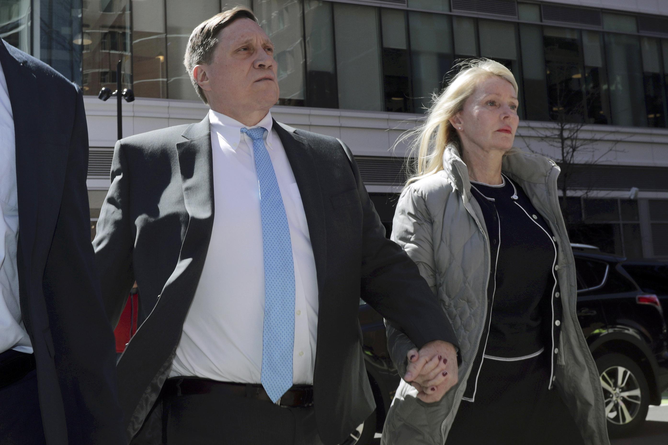 Parents convicted in college scam remain free during appeal | AP News