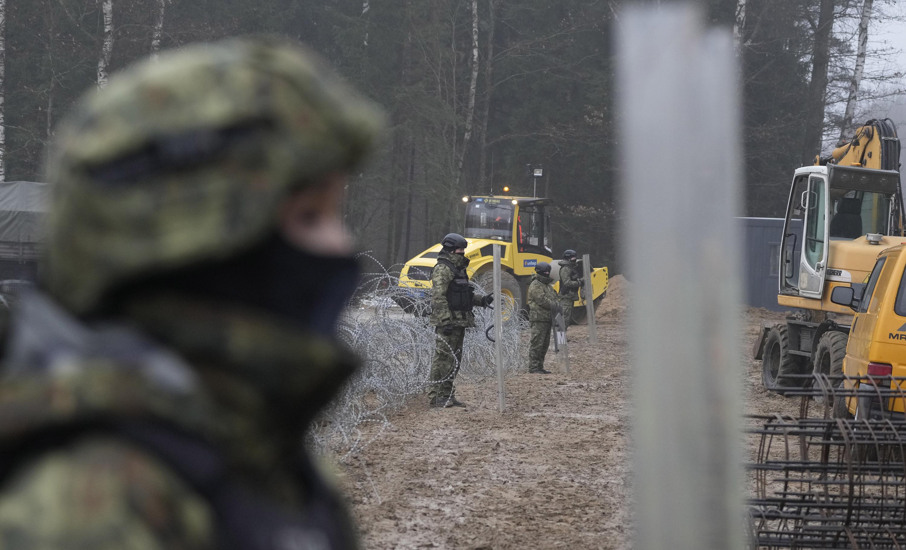 Poland starts building metal wall on border with Belarus | AP News