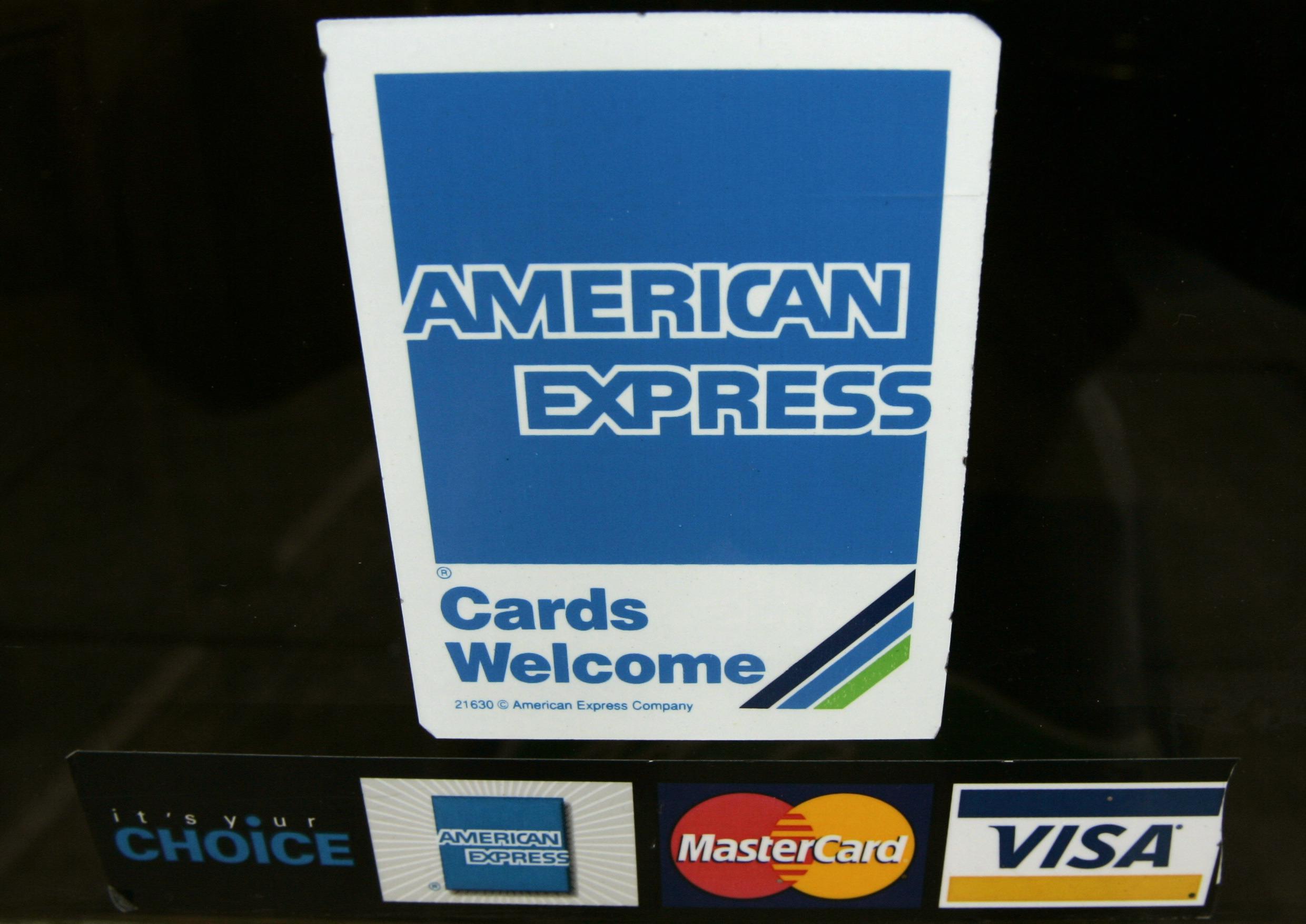 AmEx profits up 3%, but still sets cash aside for downturn | AP News