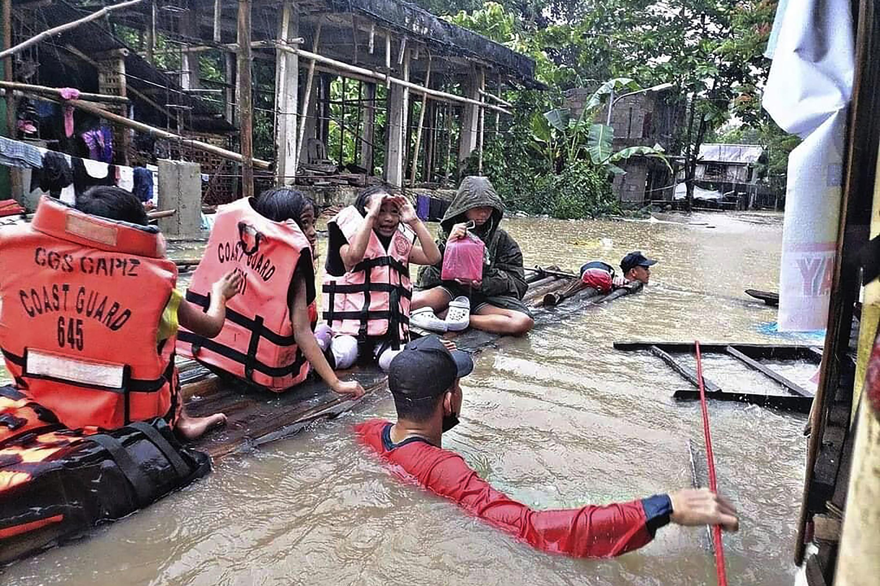 Flooding, landslides kill at least 25 people in Philippines | AP News