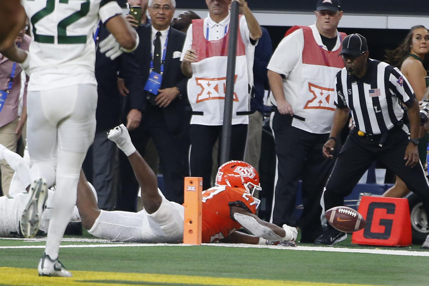 Baylor holds on for Big 12 title, knocks Okla St out of CFP | AP News