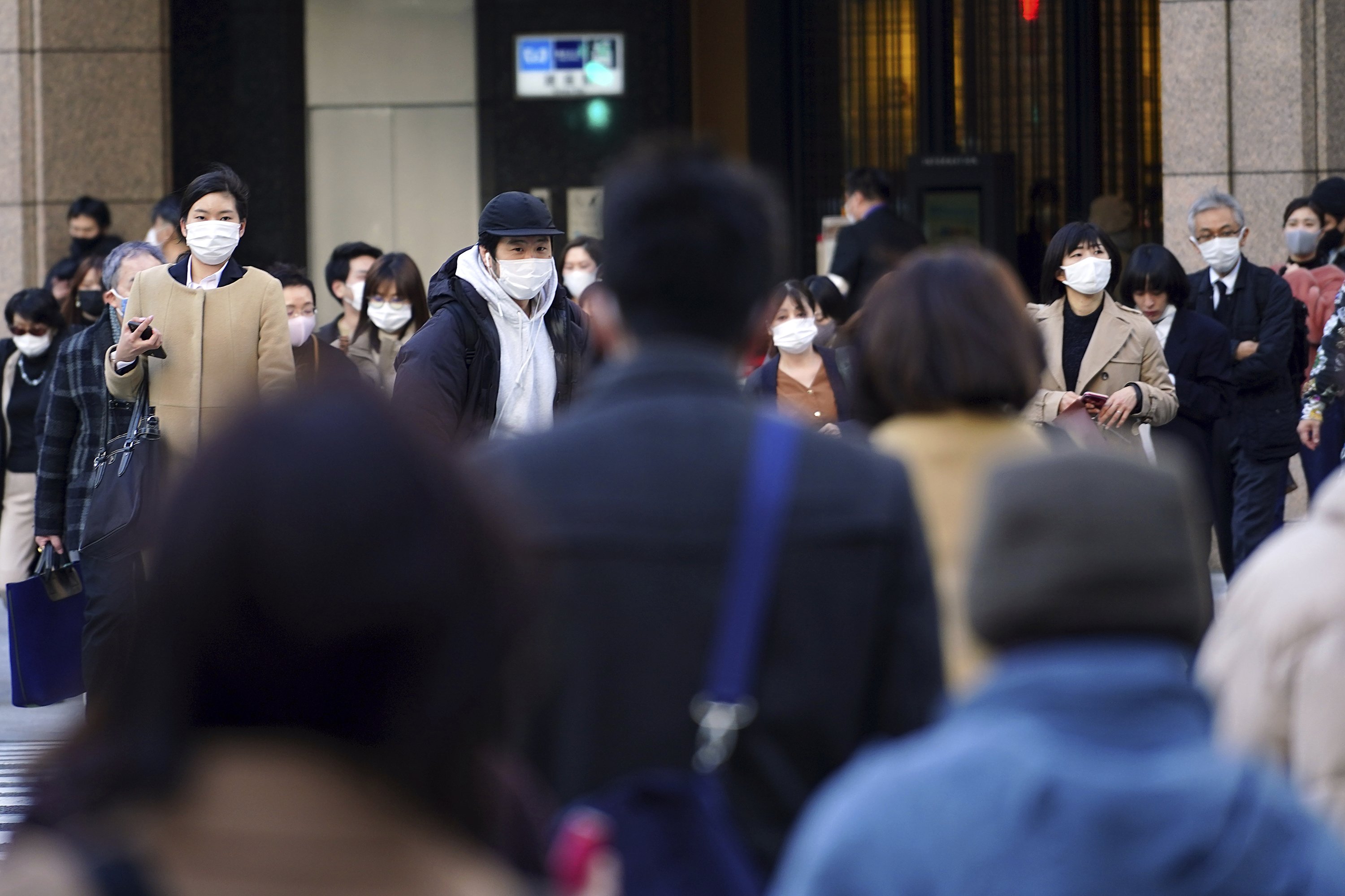 Japan partly ending pandemic emergency, keeps it for Tokyo | AP News
