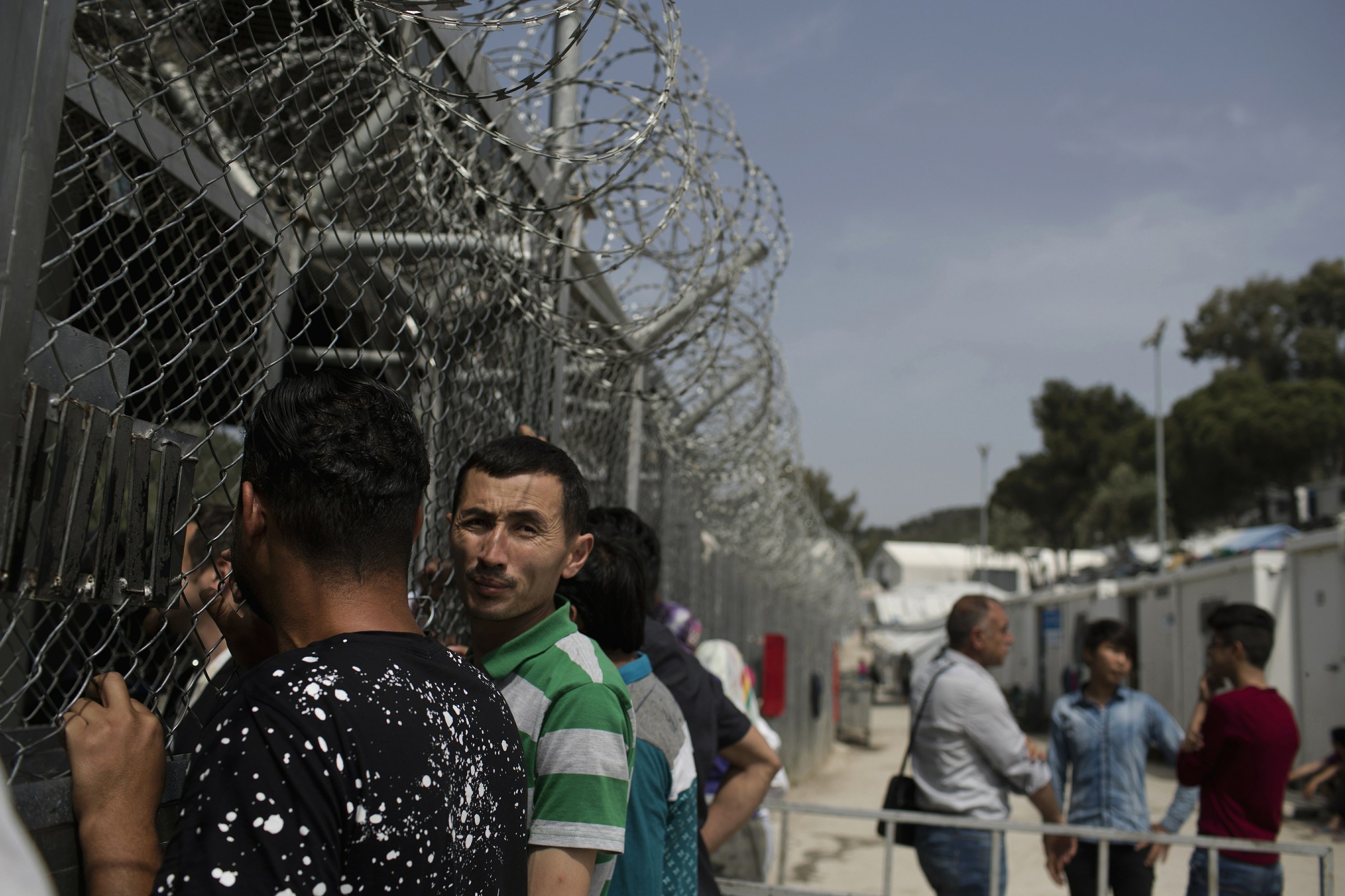 Amid protests, Greece suspends migrants detention plan | AP News