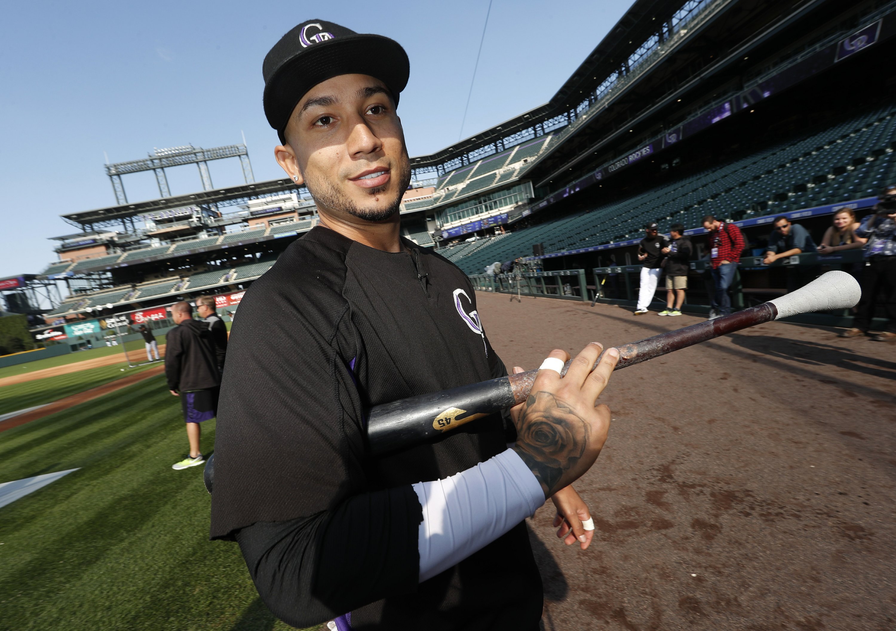 Gonzalez glad to stay with Rockies, even at a discount | AP News