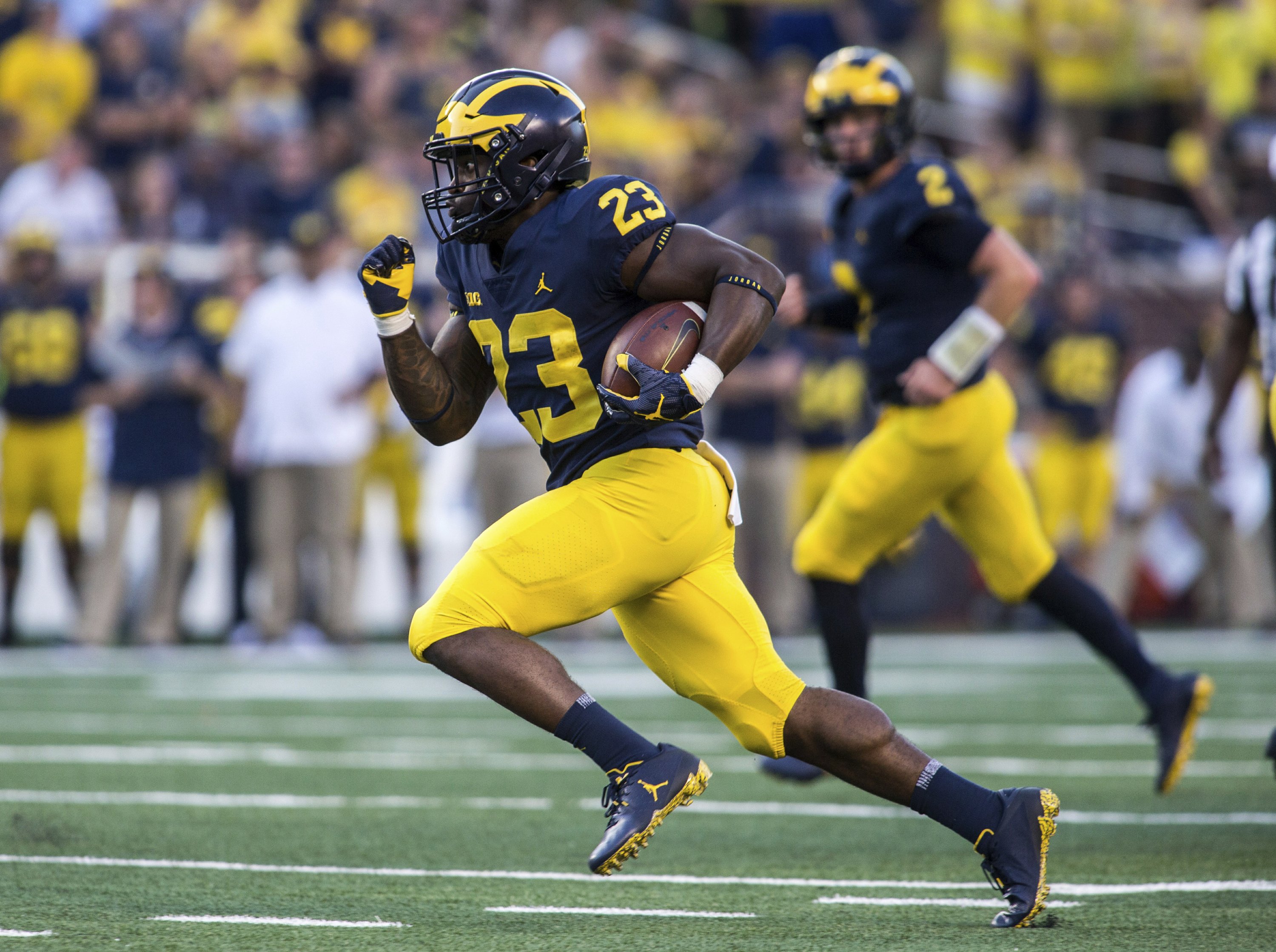 Michigan dismisses RB Samuels after domestic violence charge | AP News