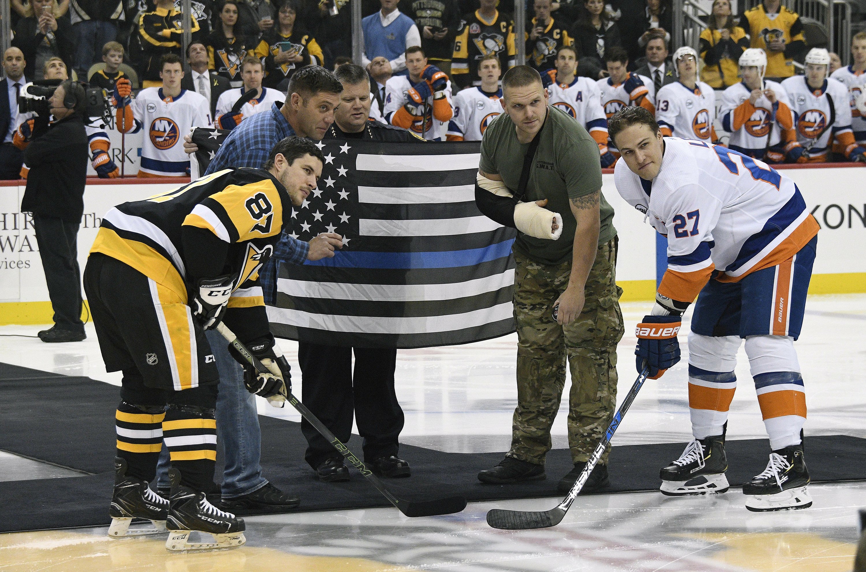 Penguins honor shooting victims with ceremony, special logo | AP News