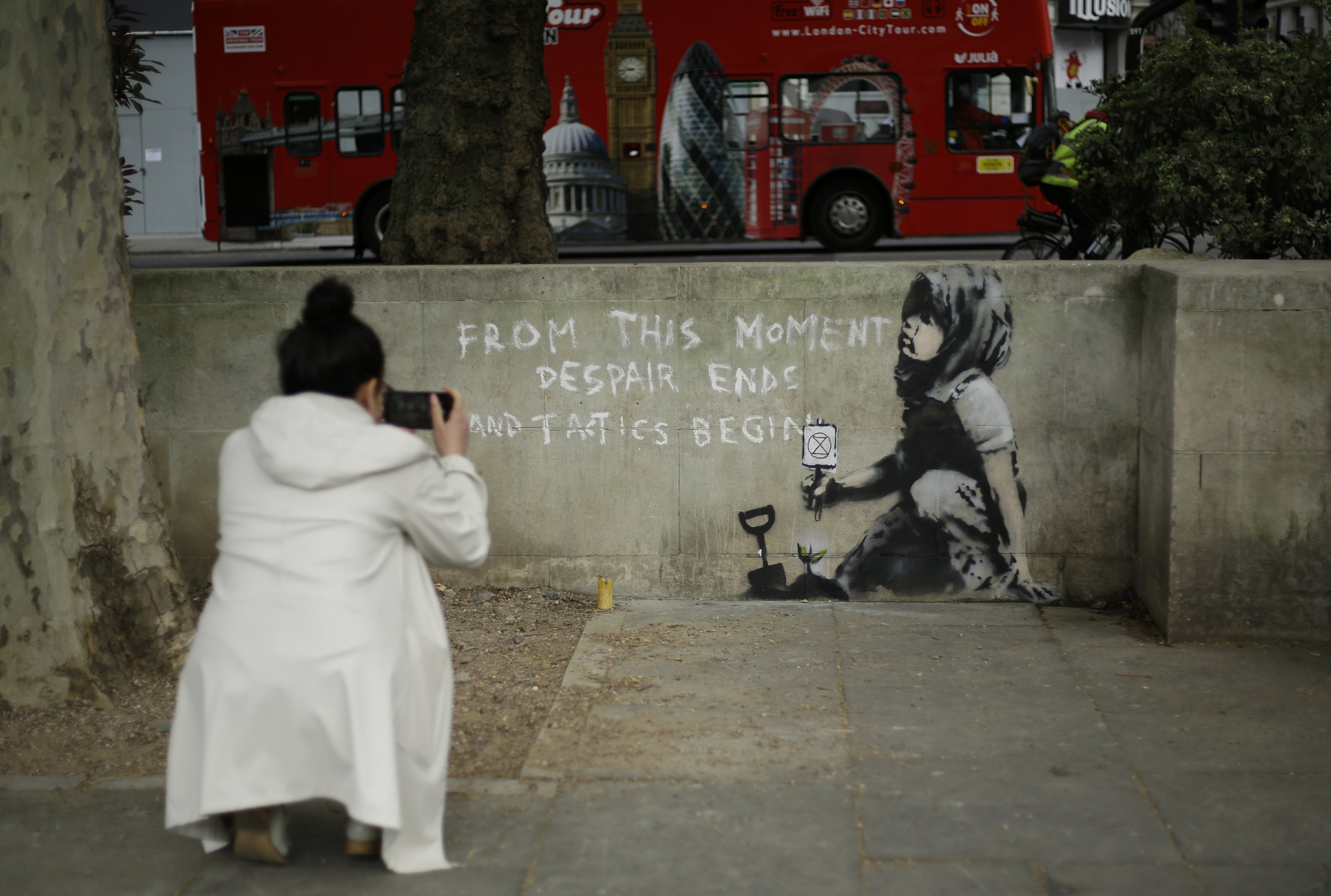 Climate mural emerges after London protests; Is it Banksy? | AP News