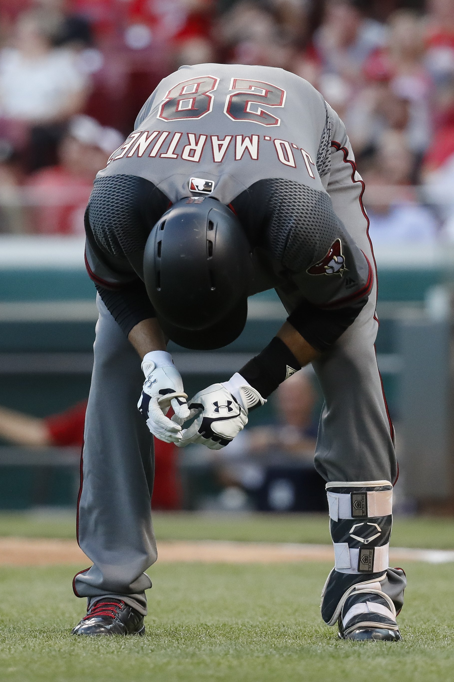 Martinez hurts hand, Diamondbacks fall to Reds 4-3 in 11 | AP News