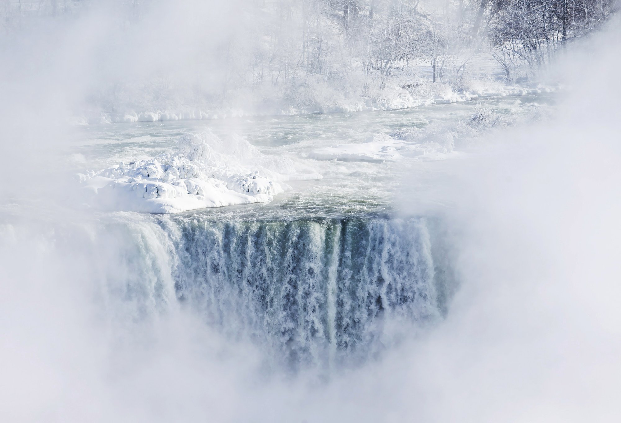 "Ice and water flows over the brink of the Horseshoe Falls in Niagara ...