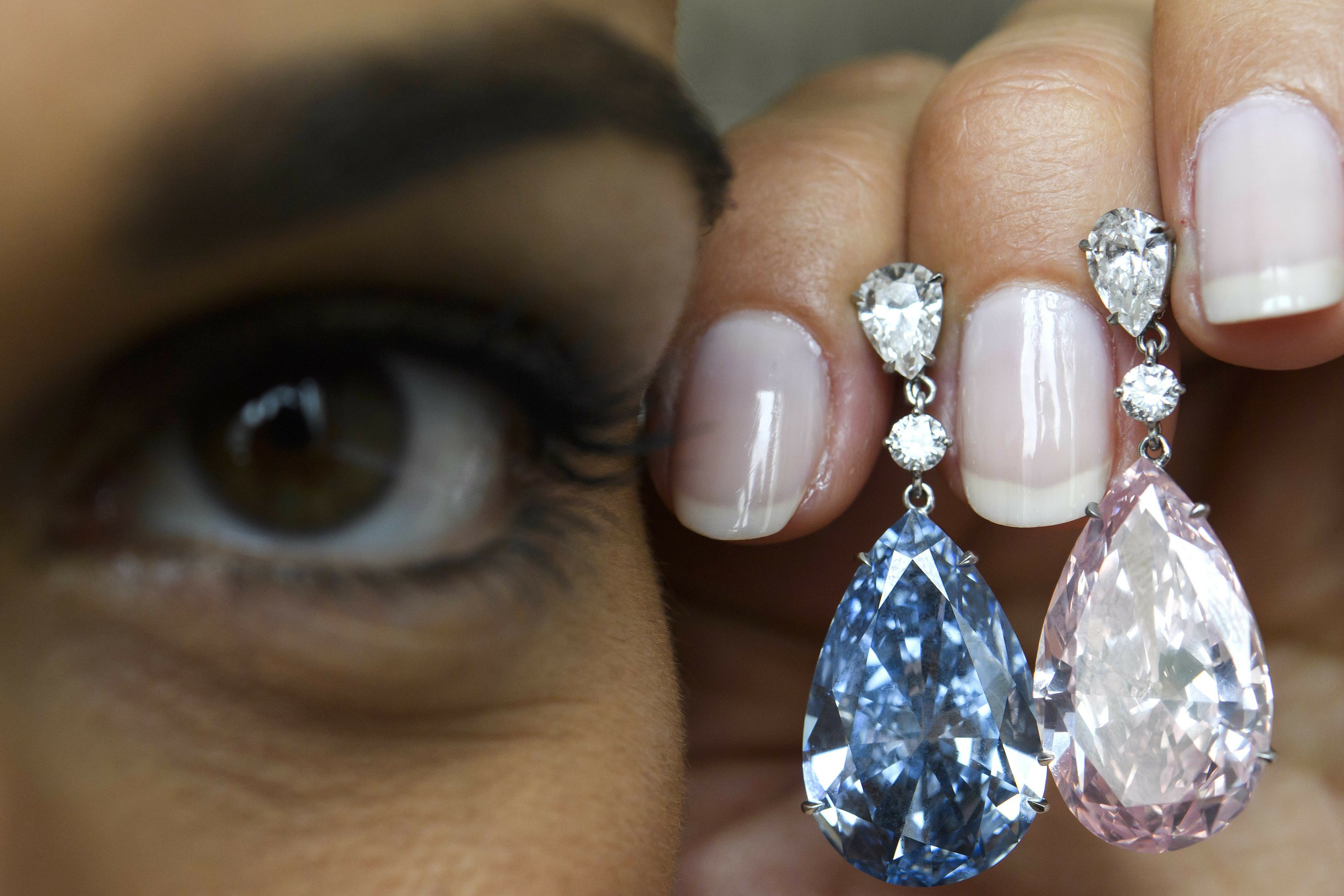 Sotheby's sells pink, blue diamond earrings for about $51M | AP News