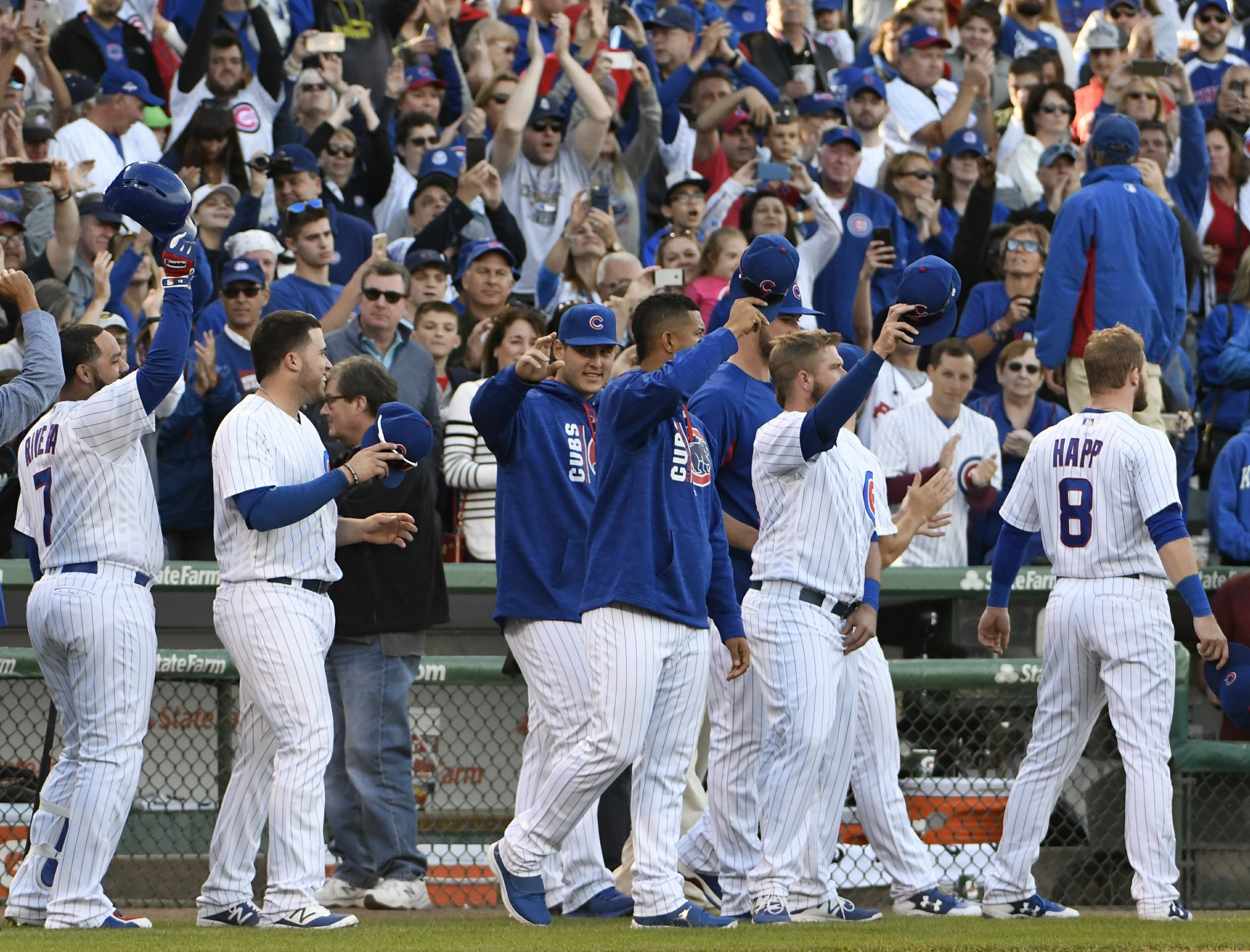 Different feel for champion Cubs heading into these playoffs | AP News